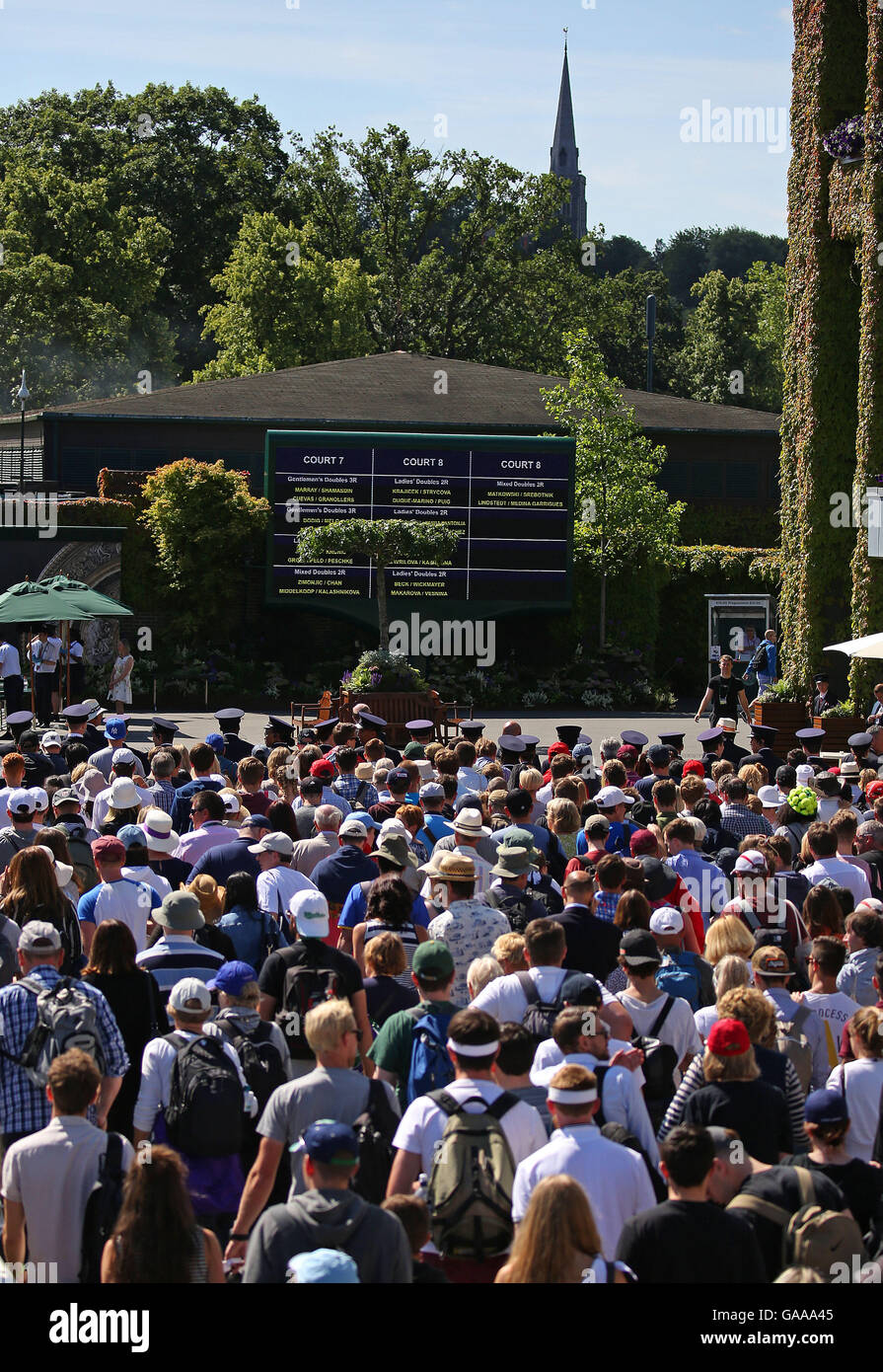 Spectators are led in on day seven of the Wimbledon Championships at ...