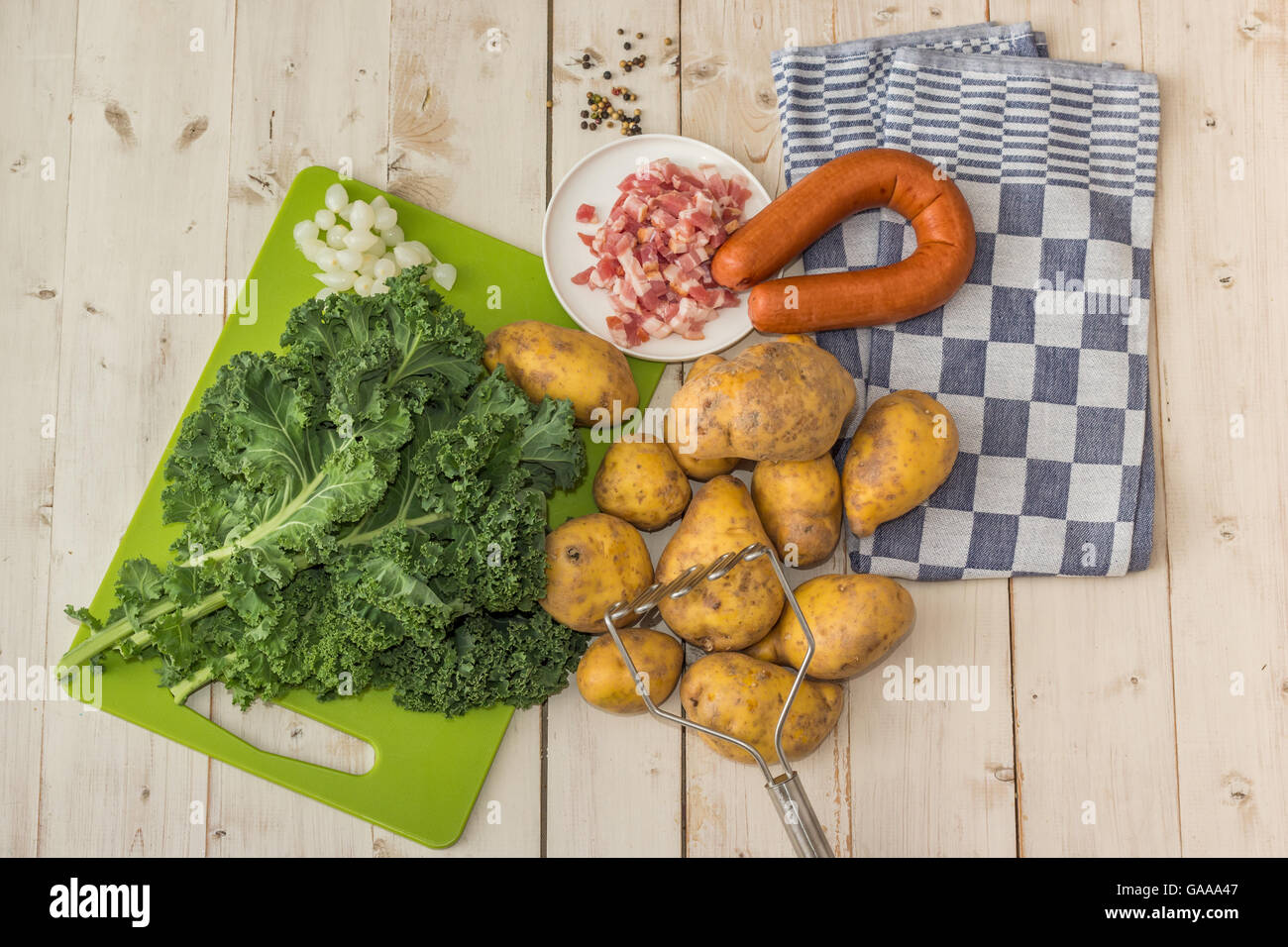 Ingredients to make typical dutch boerenkool with kale, sausage, bacon ...