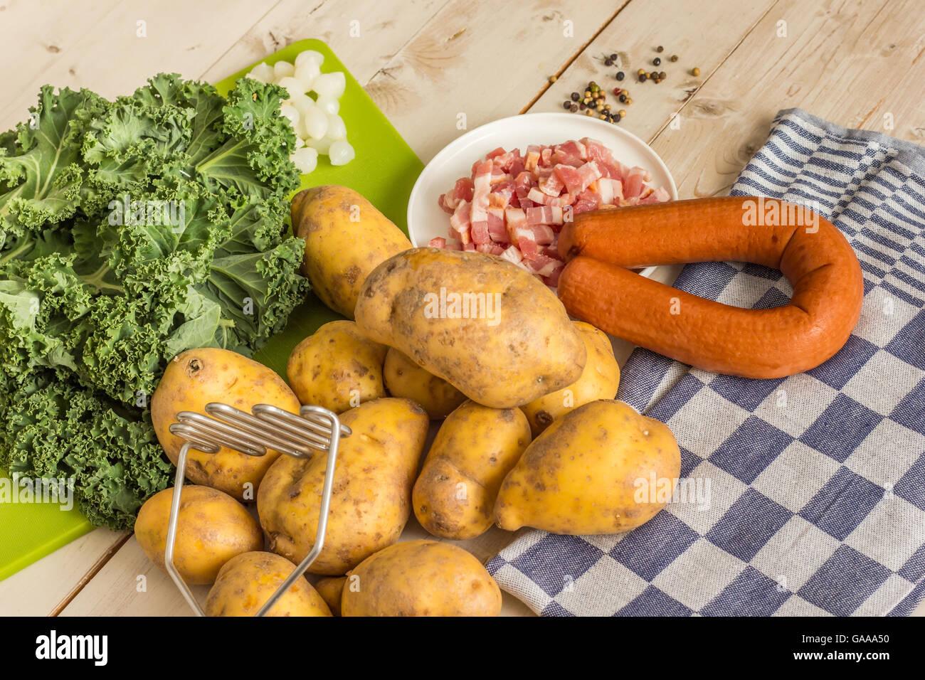 Ingredients to make typical dutch boerenkool with kale, sausage, bacon ...
