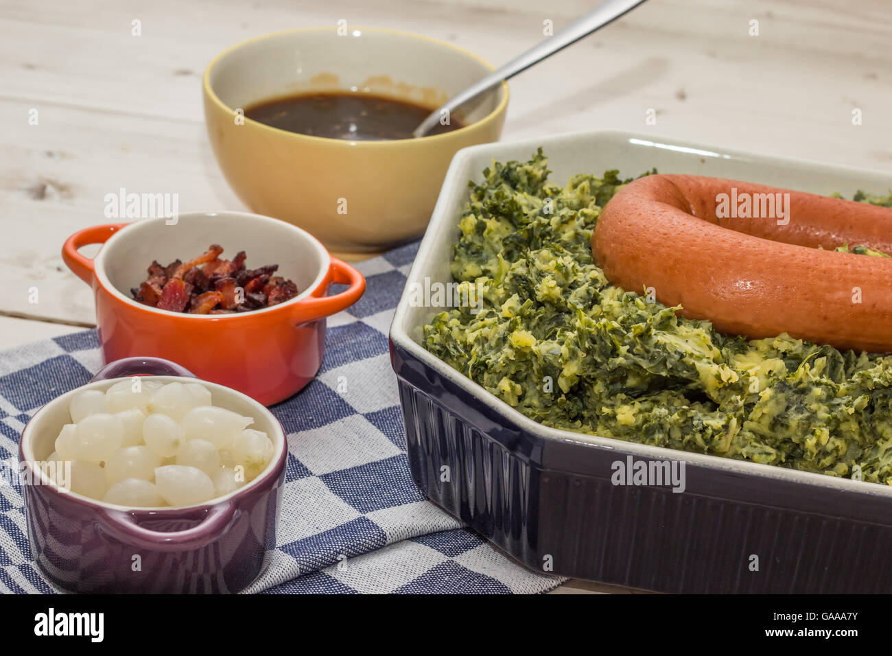 Typical dutch dish boerenkool with kale, mashed potatoes, sausage ...