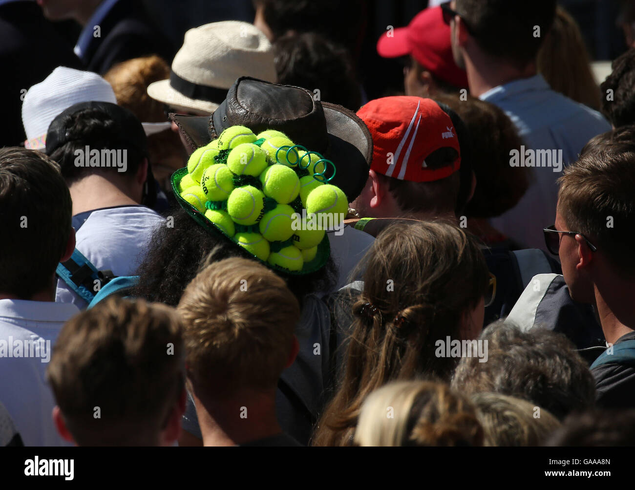 Spectators are led in on day seven of the Wimbledon Championships at ...