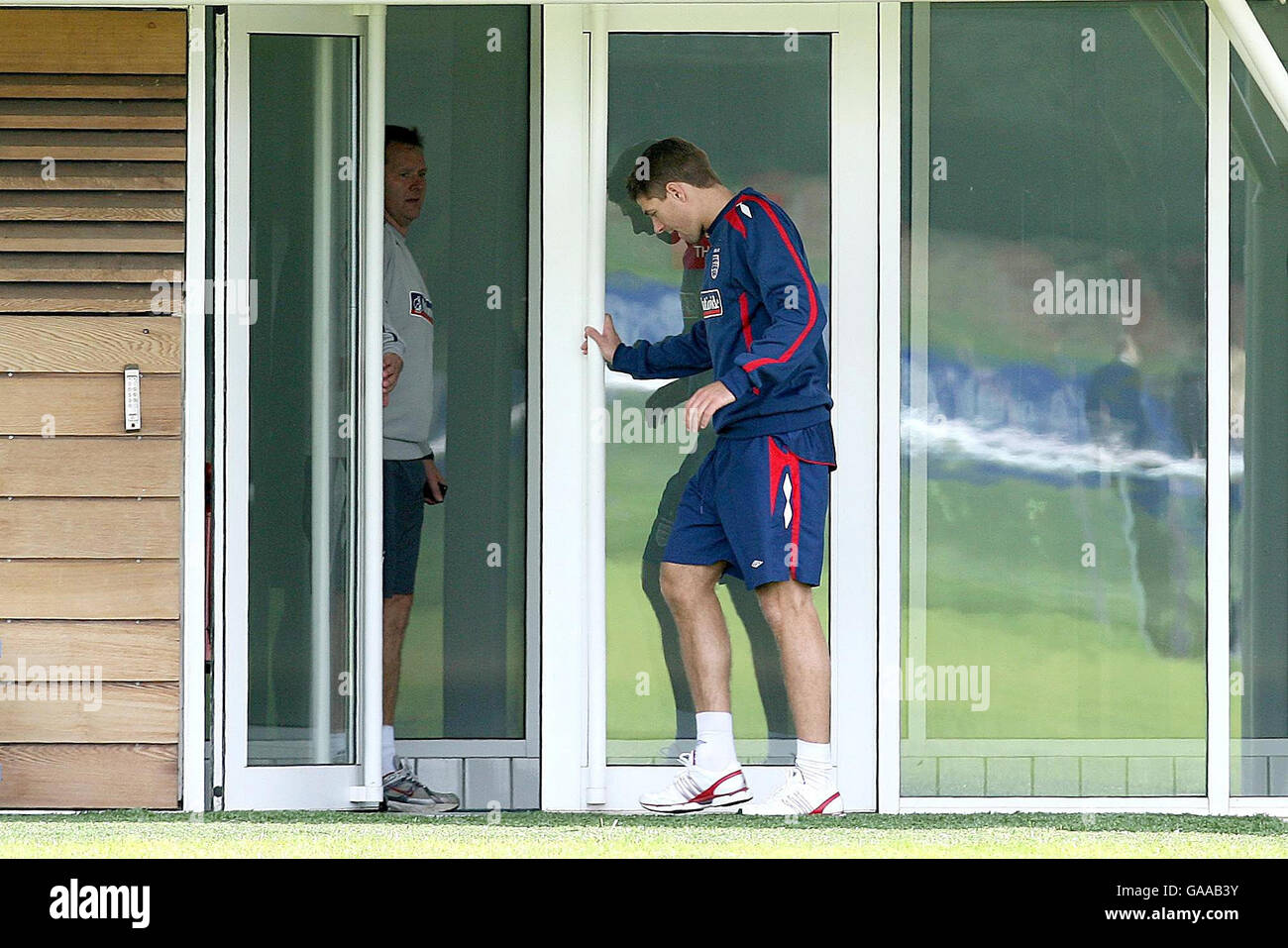 Steven Gerrard (right) heads to the treatment room with Gary Lewin ...