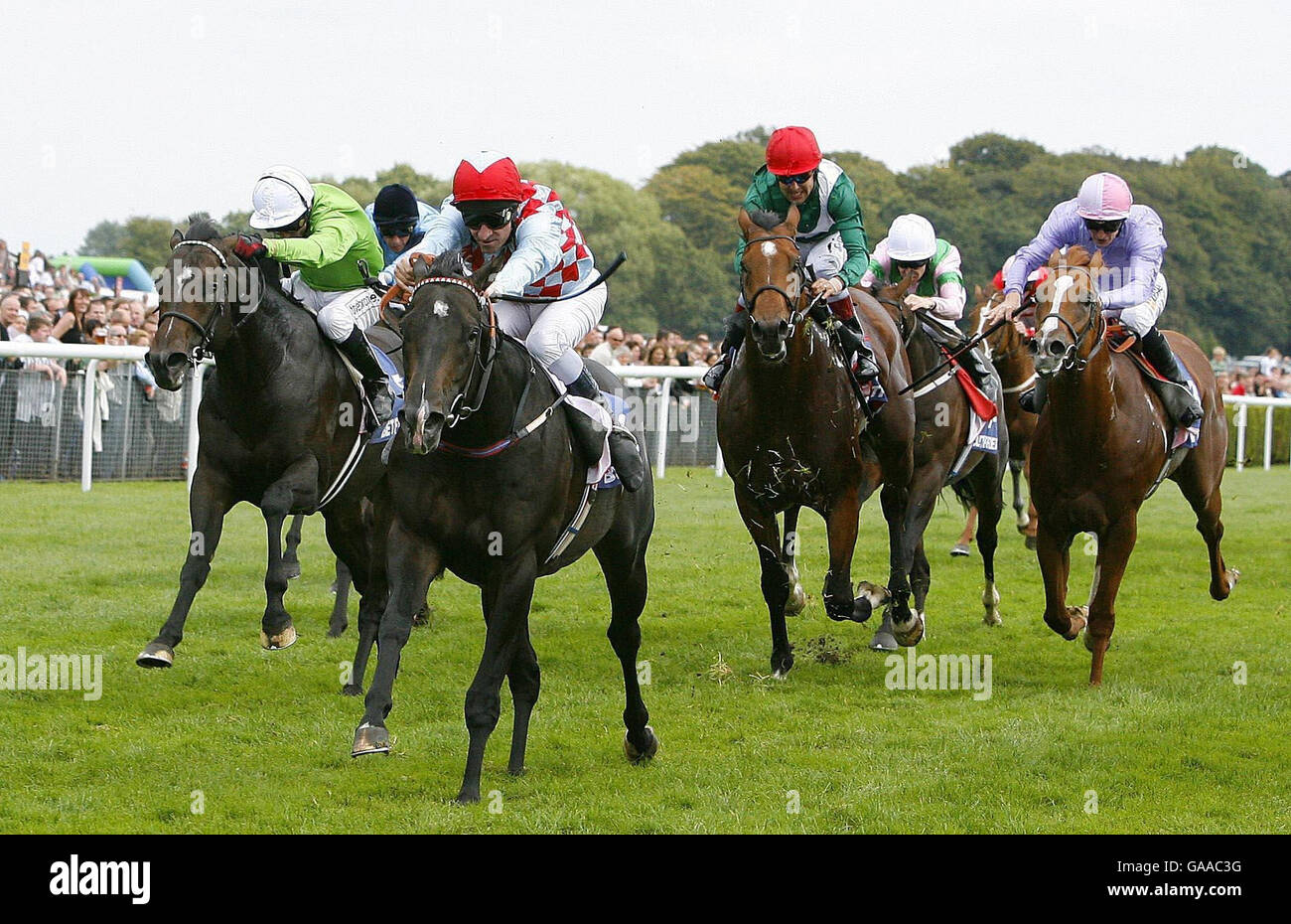 Horse Racing - Haydock Park Racecourse. Red Clubs (centre) and jockey ...