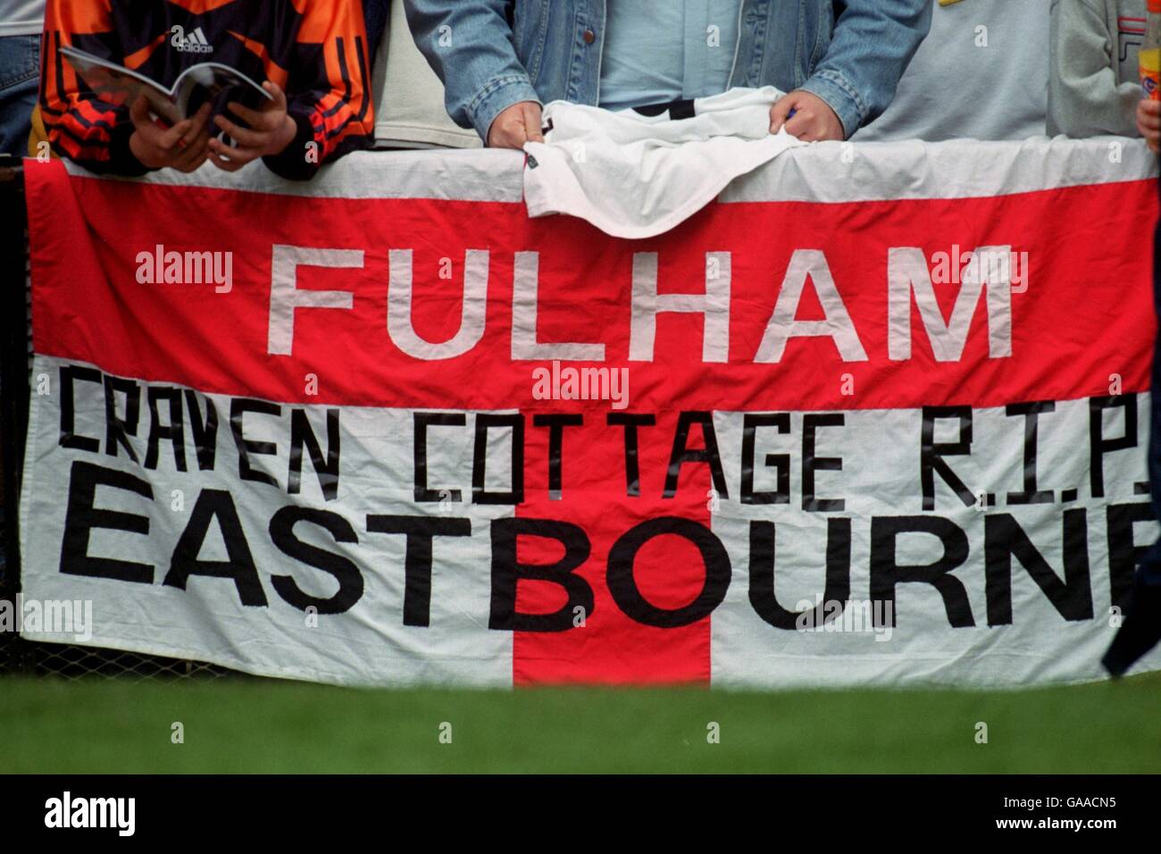 A Fulham fan with a flag paying his last respects to their Craven ...
