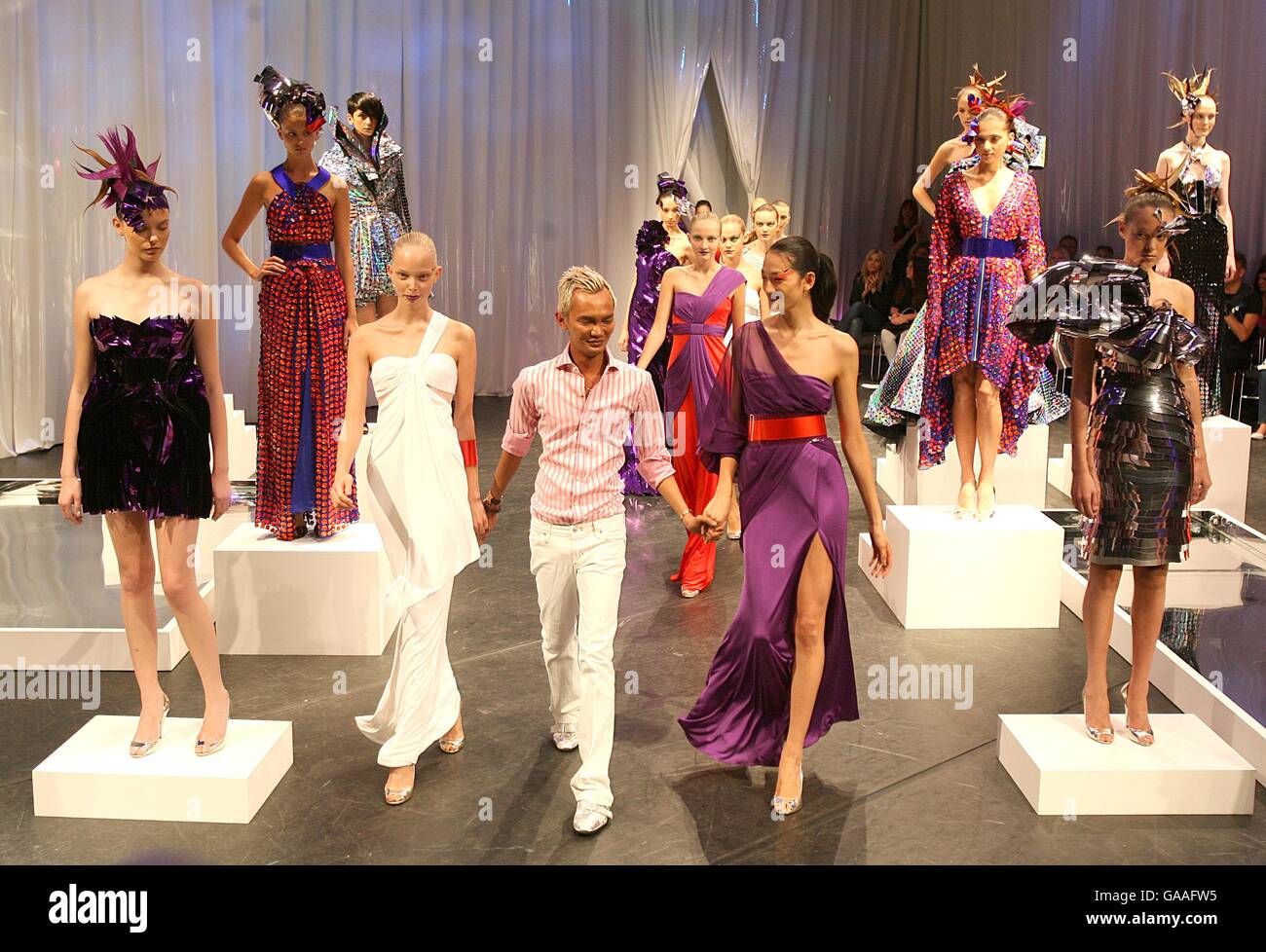 Designer Ashley Isham appears on stage with the models following his ...