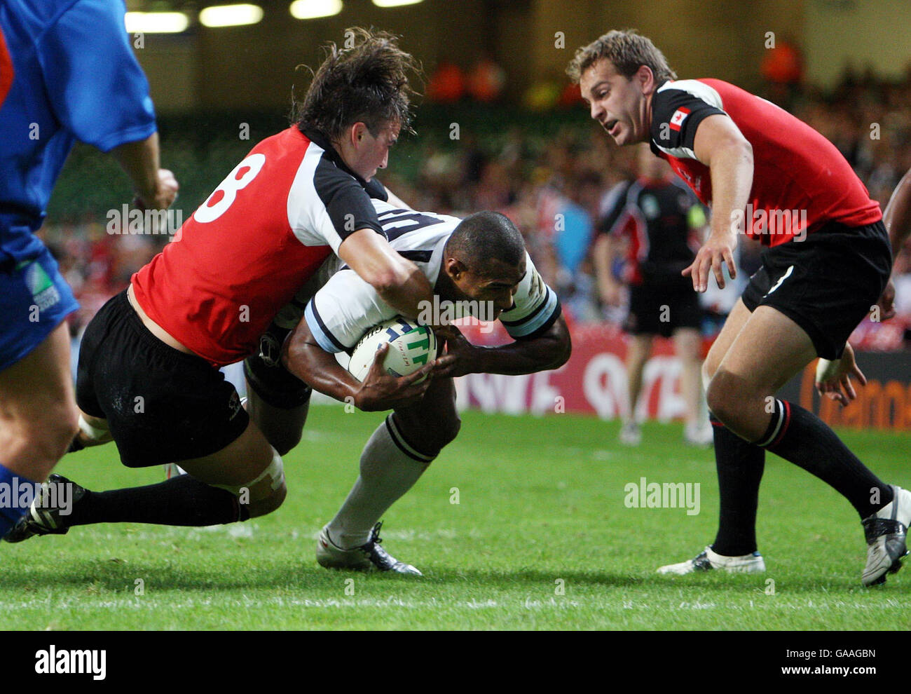Fiji's Graham Dewes crosses for his side's second try during the IRB ...