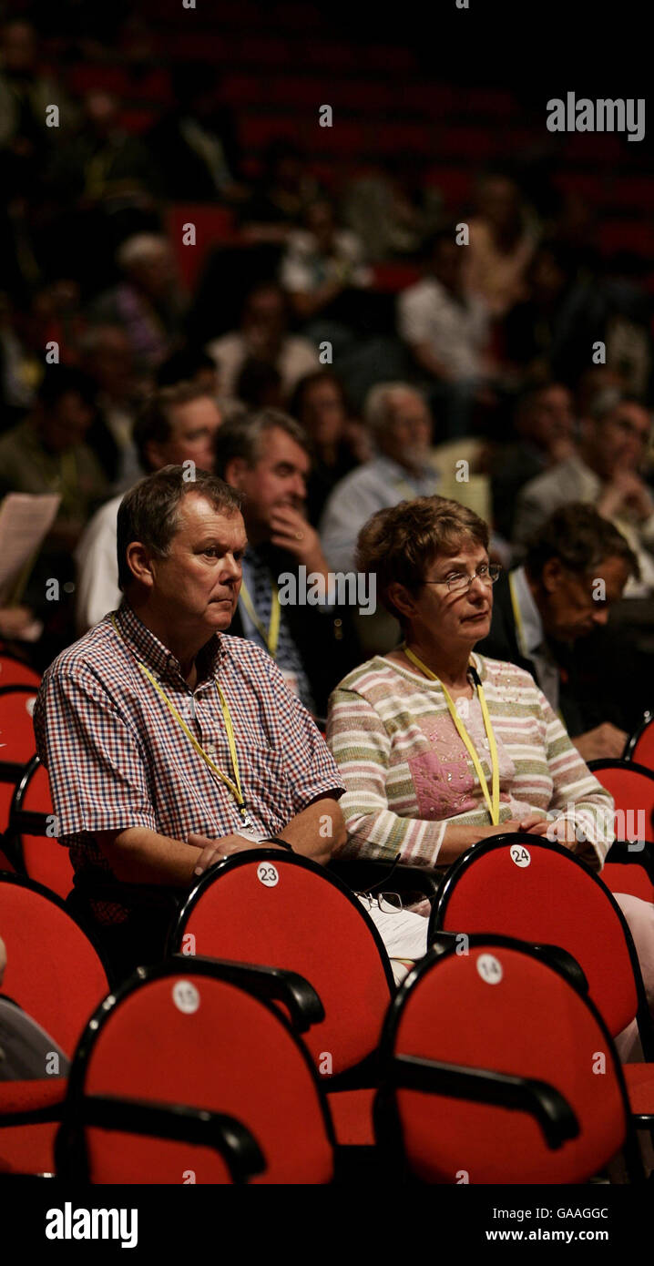 Members of the Liberal Democrat party sit and listen to the start of ...