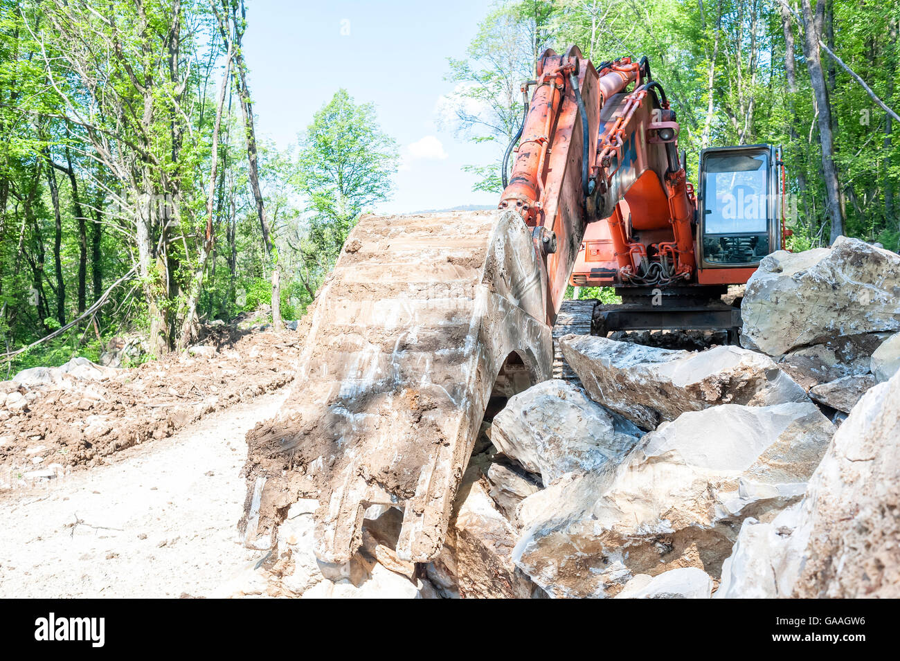 Excavator with big shovel to work with rocks Stock Photo - Alamy