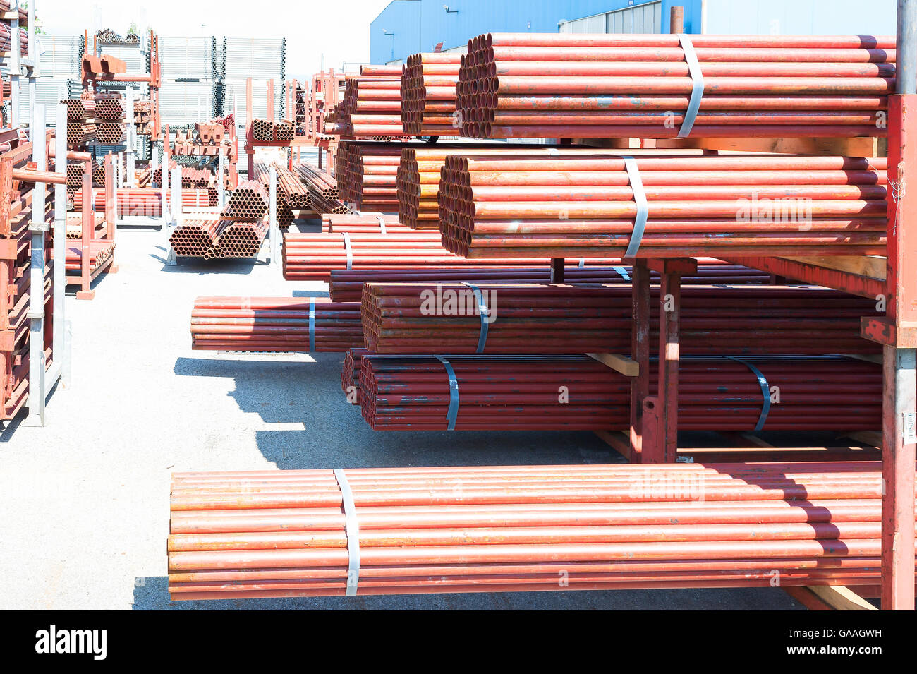Steel Pipes bunch on the rack in warehouse Stock Photo - Alamy