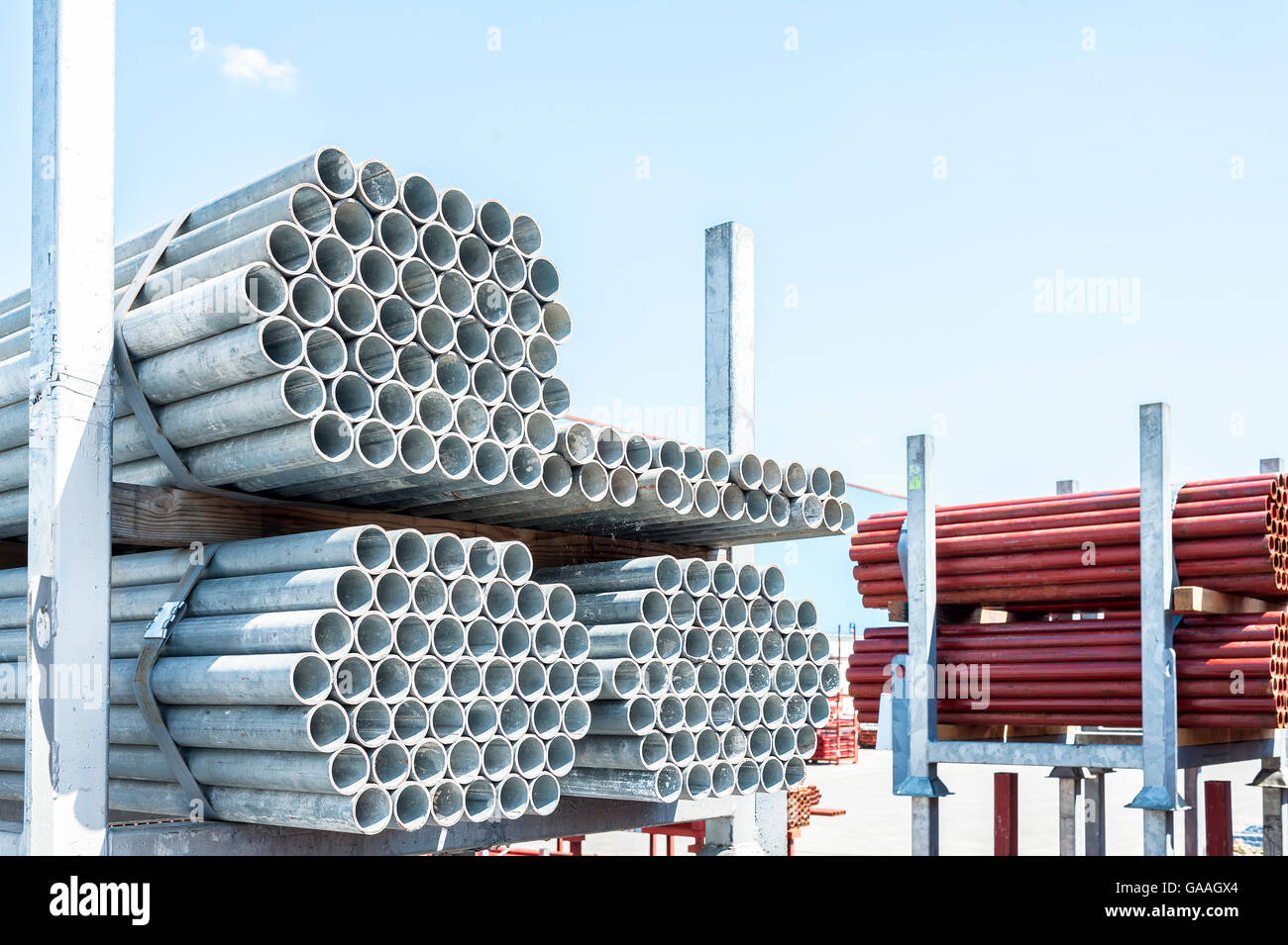 Steel Pipes bunch on the rack in warehouse Stock Photo - Alamy