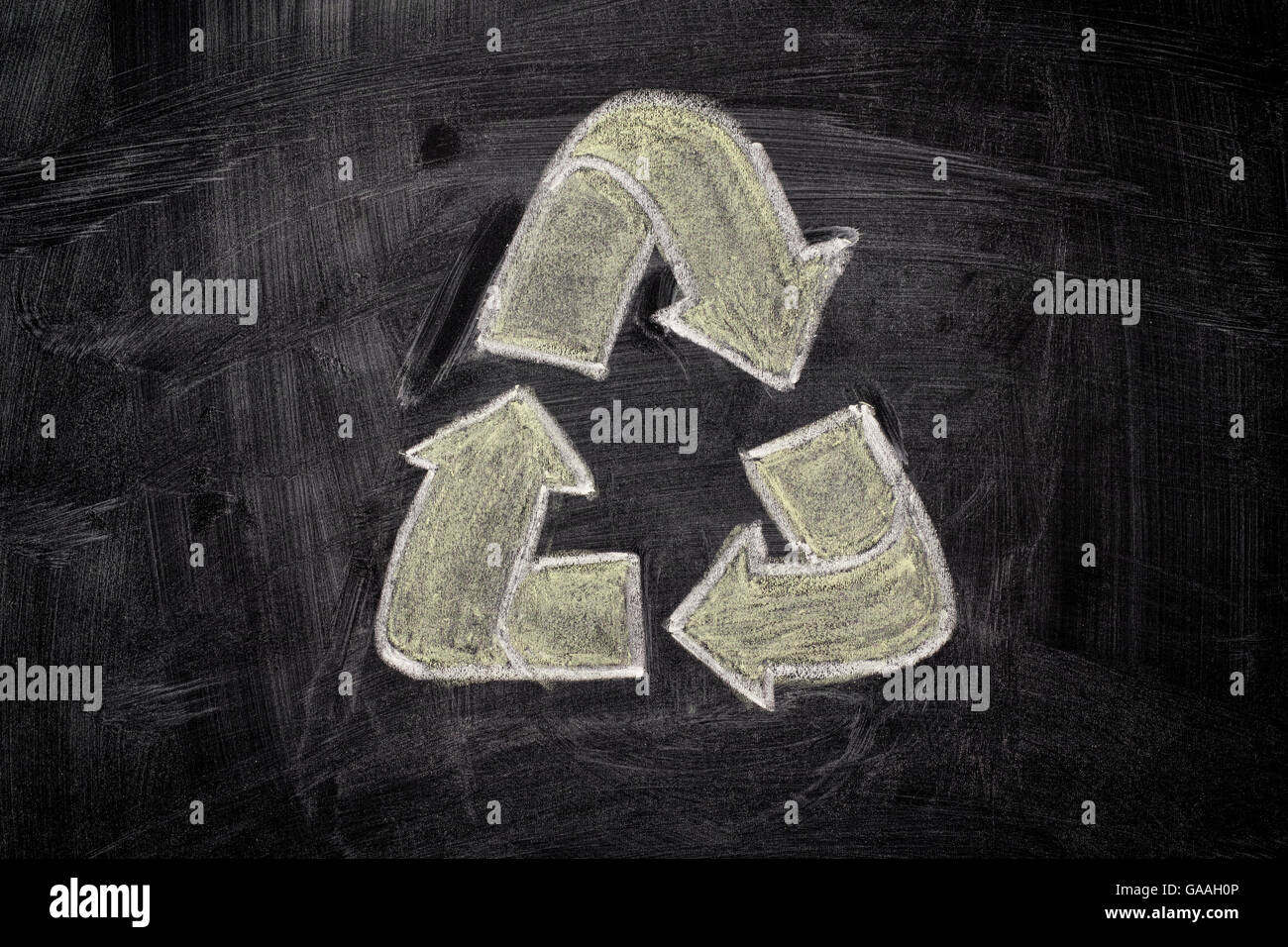 Recycle sign on black chalkboard background. Close up Stock Photo - Alamy