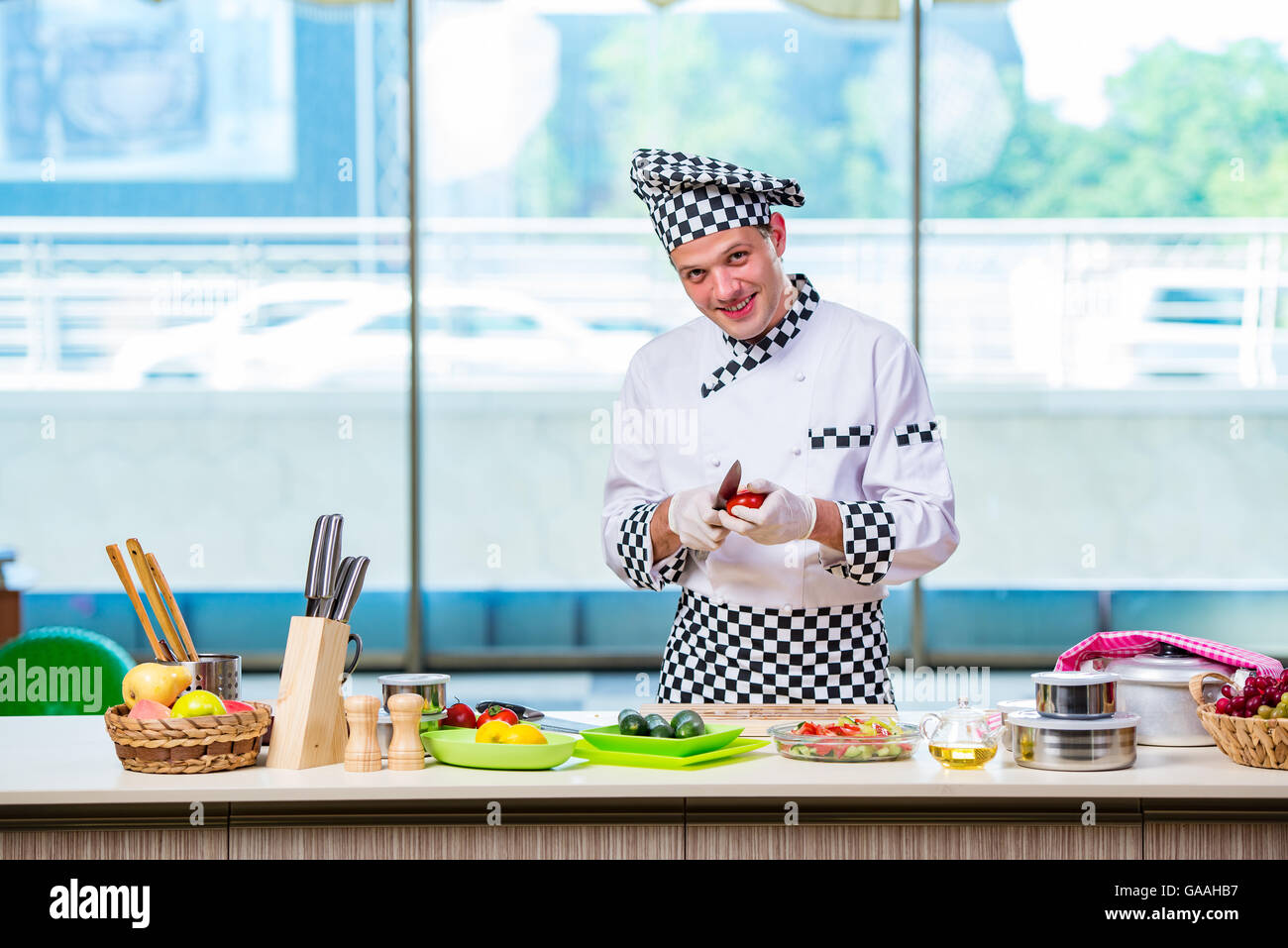 Male cook preparing food in the kitchen Stock Photo - Alamy