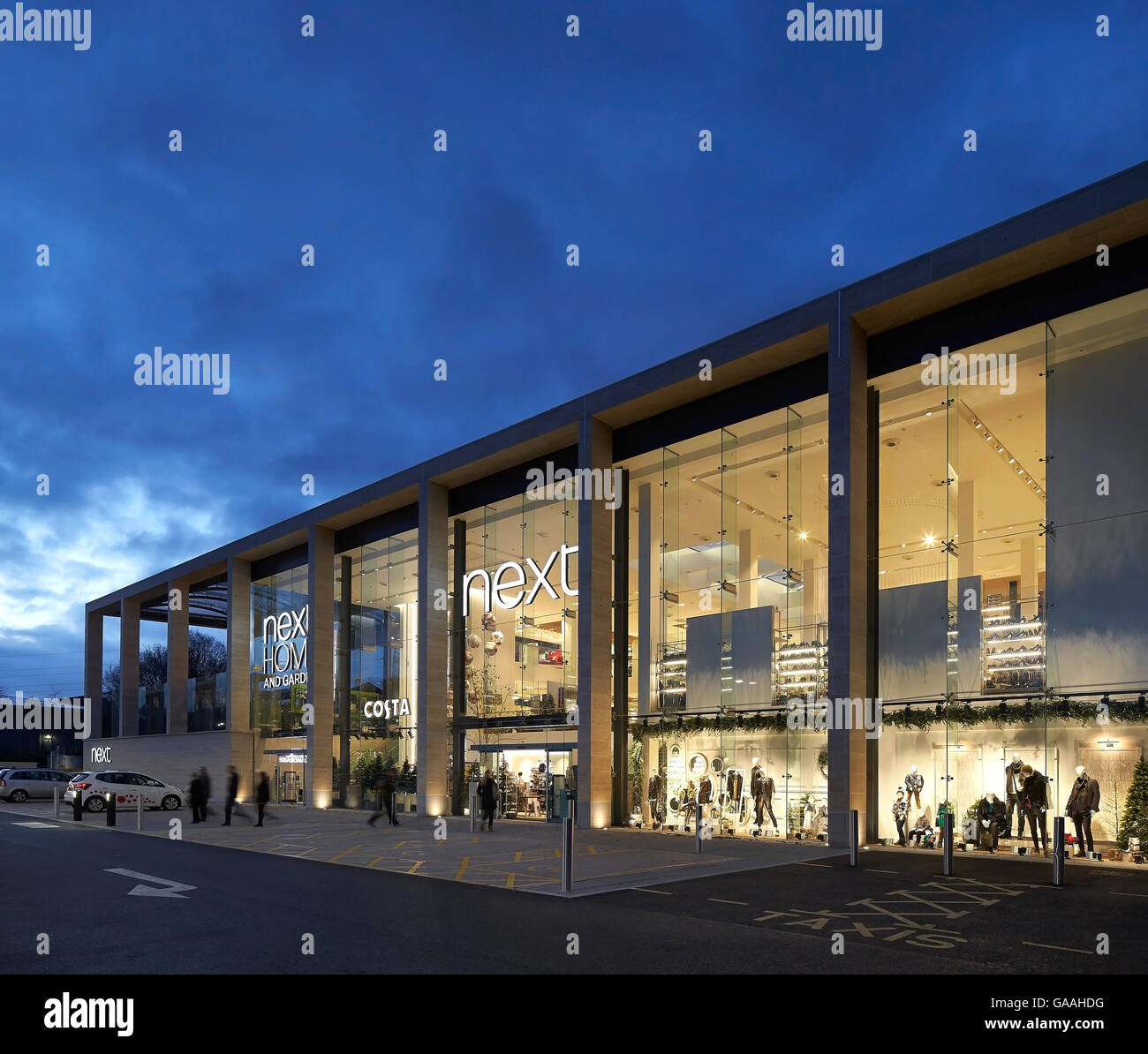 Dusk perspective of main entrance with lit interior. Next - Home and ...