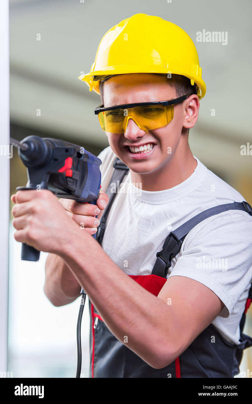 Man drilling the wall with drill perforator Stock Photo - Alamy