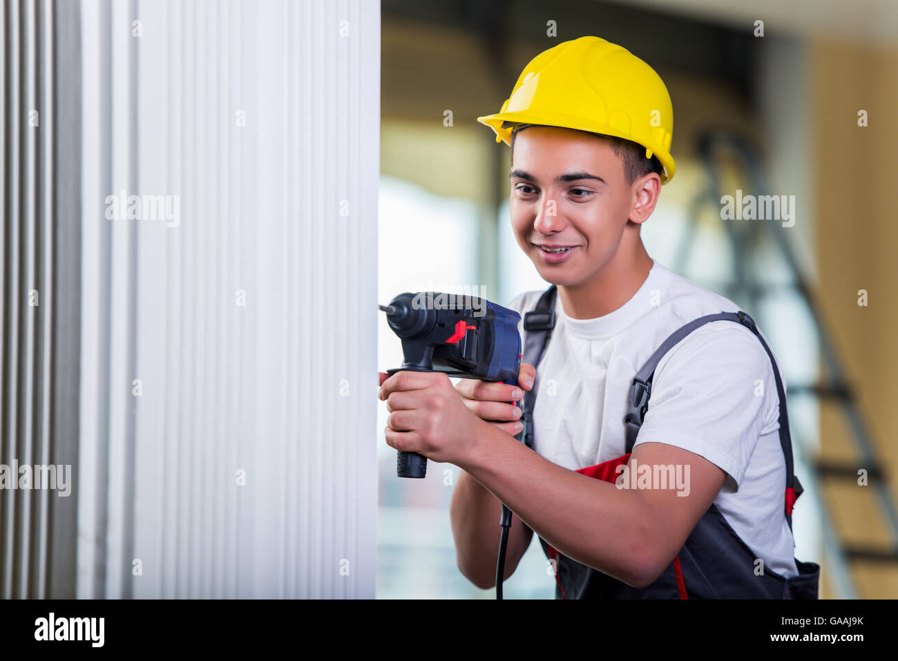 Man drilling the wall with drill perforator Stock Photo - Alamy