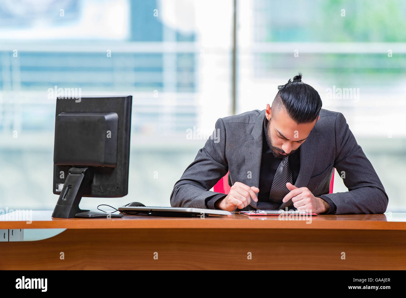 Sad businessman sitting in the office Stock Photo - Alamy