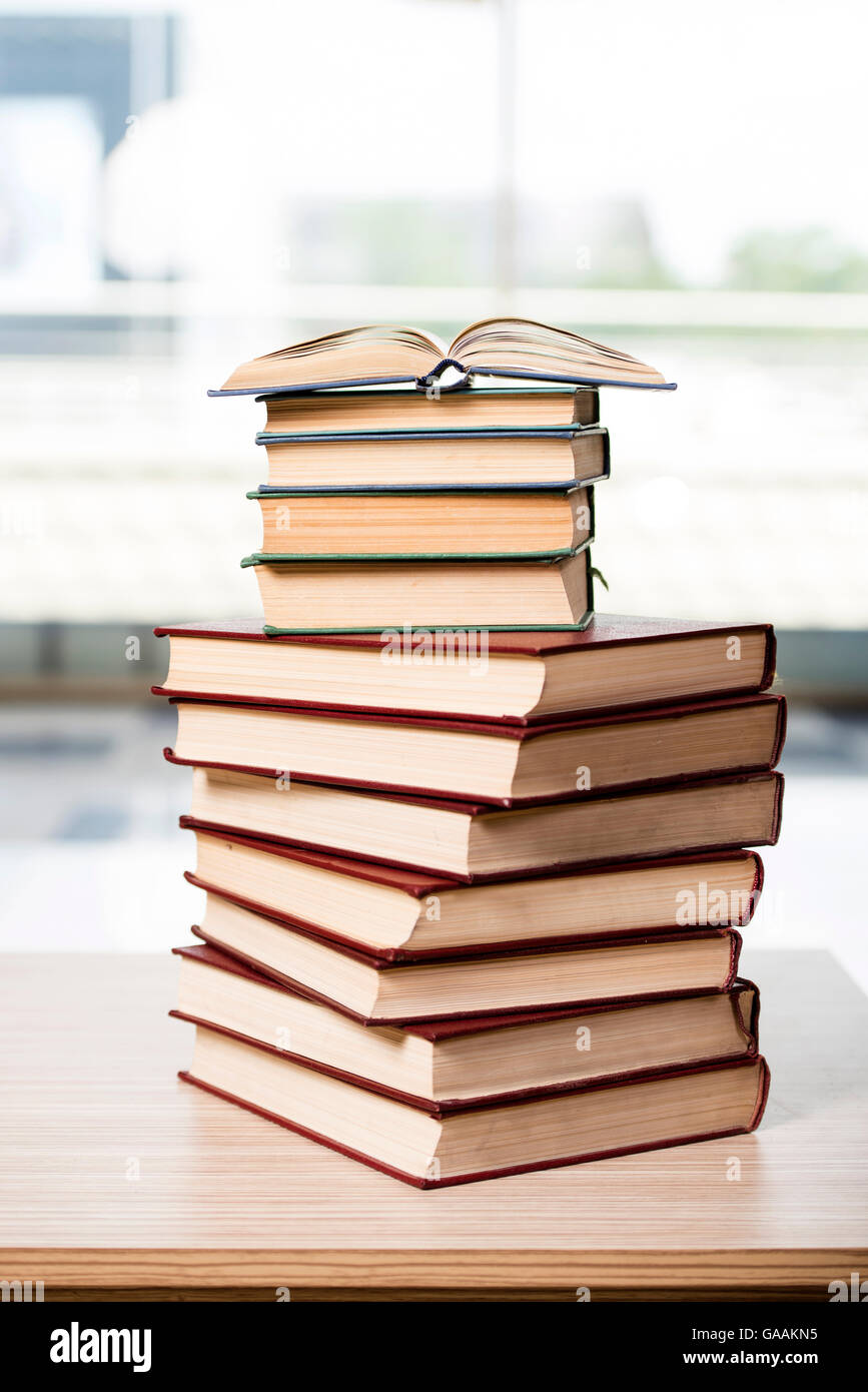 Stack of books arranged the office desk Stock Photo - Alamy