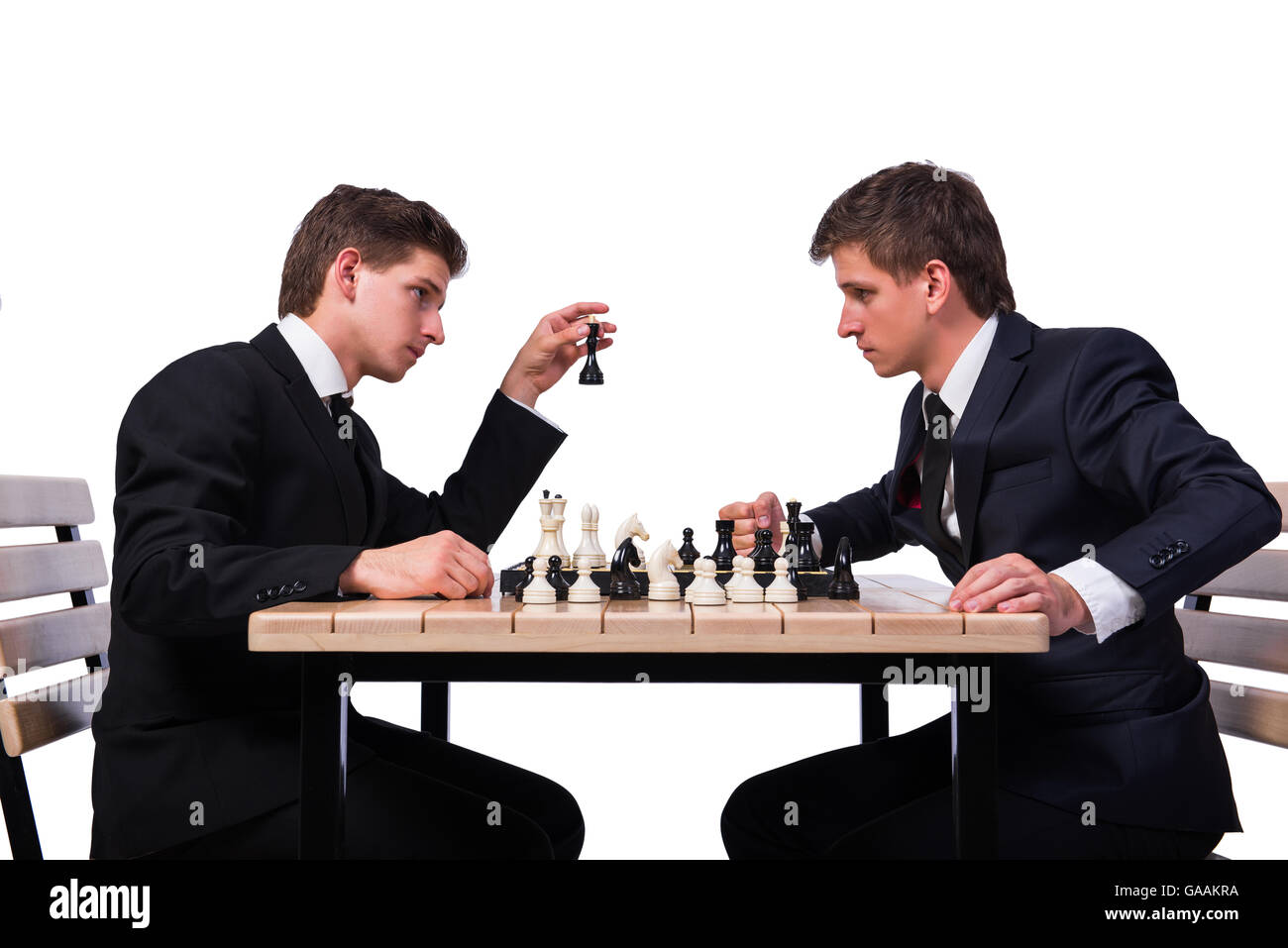 Twin brothers playing chess isolated on white Stock Photo - Alamy