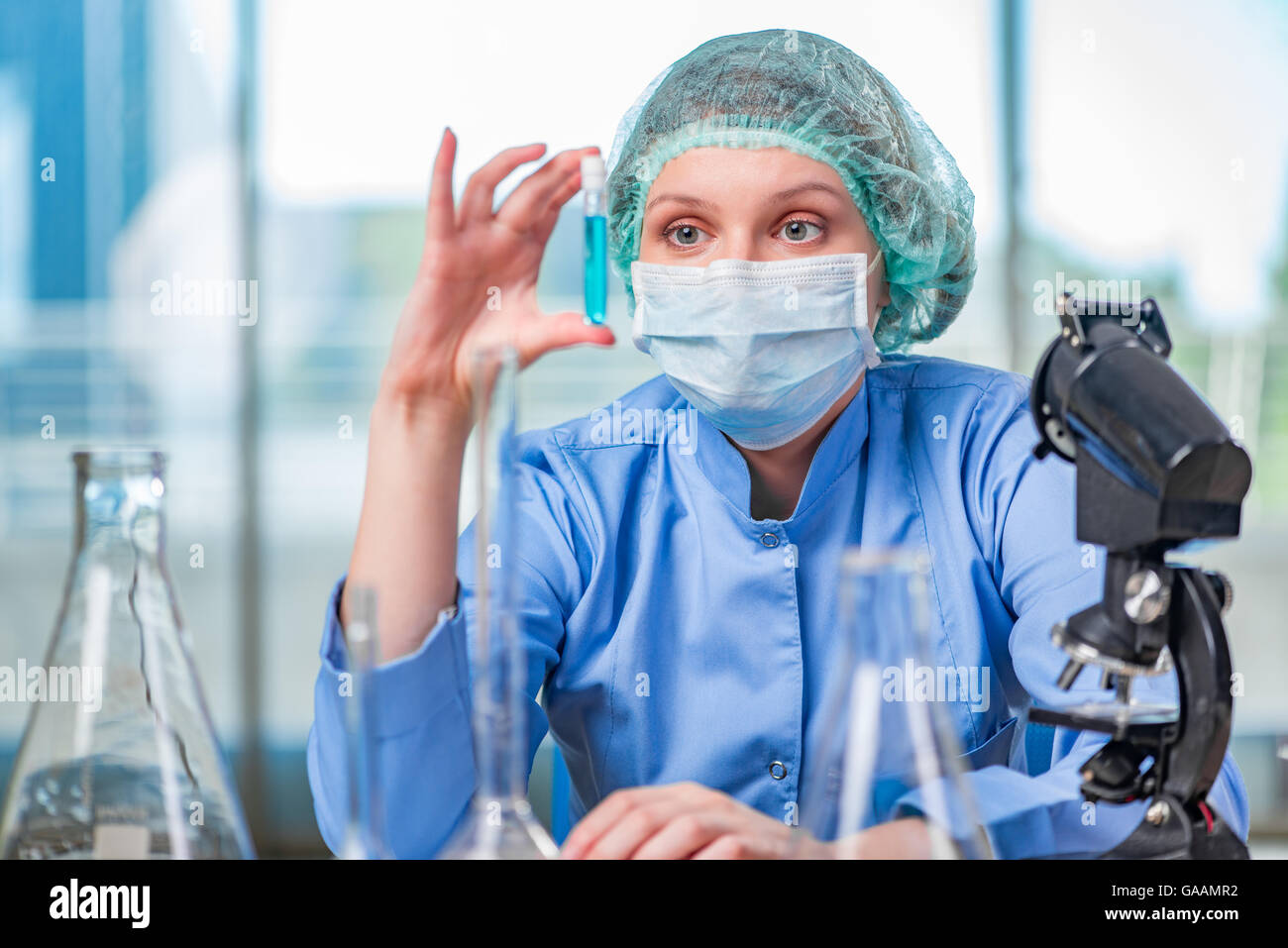 Experienced lab assistant working on chemical solutions Stock Photo - Alamy