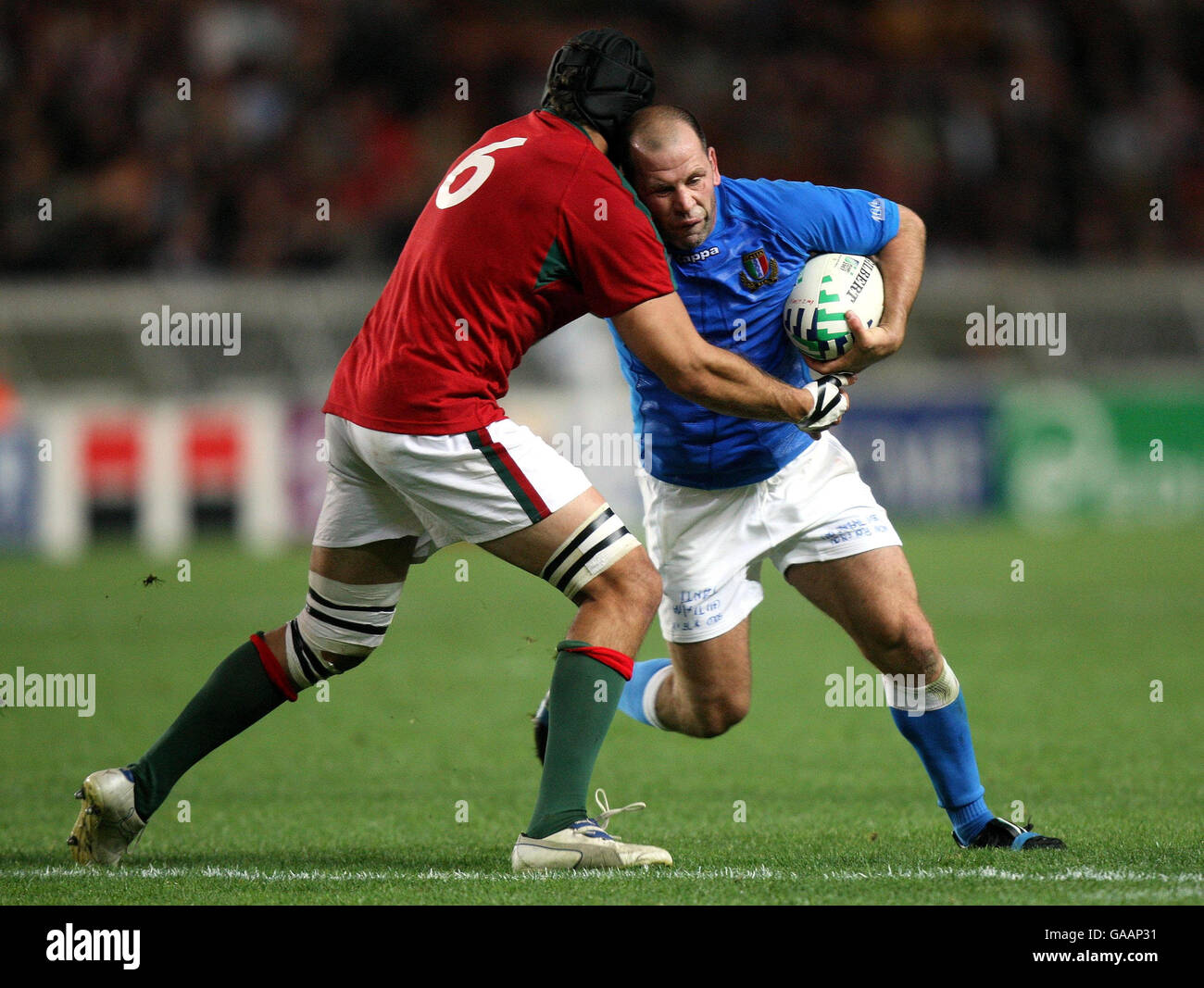 Italy's Alessandro Troncon (right) runs into the tackle of Portugal's ...