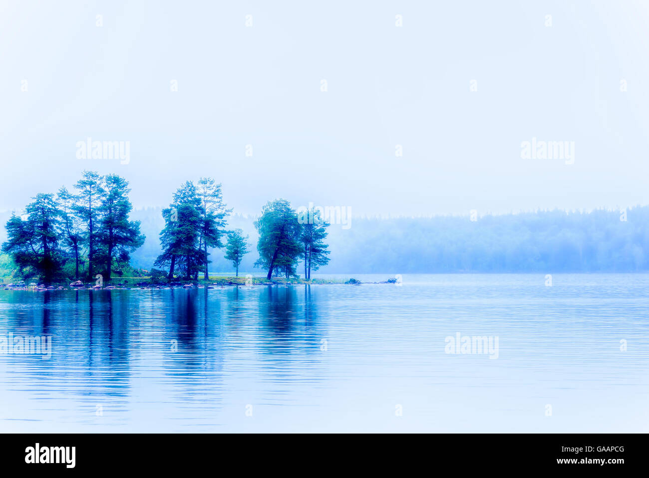 Artistic photographic landscape of island in the mist. Exaggerated and ...