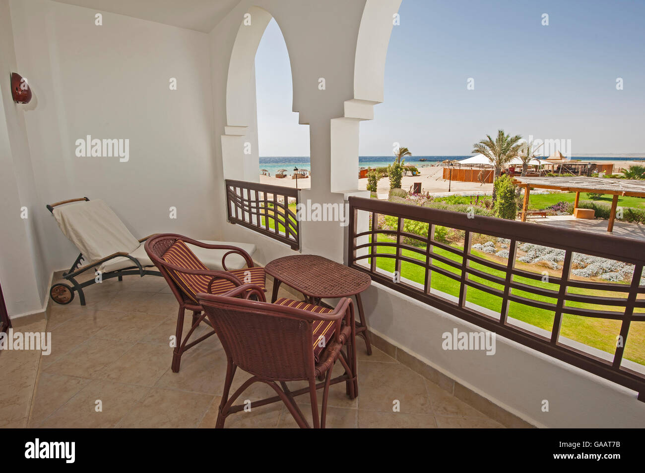 View from balcony of luxury tropical hotel resort with chairs and sun ...