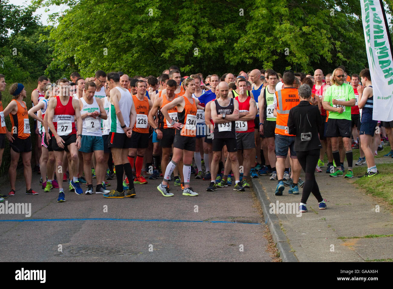 A large number of mostly men runners assemble for the start of a 10k ...