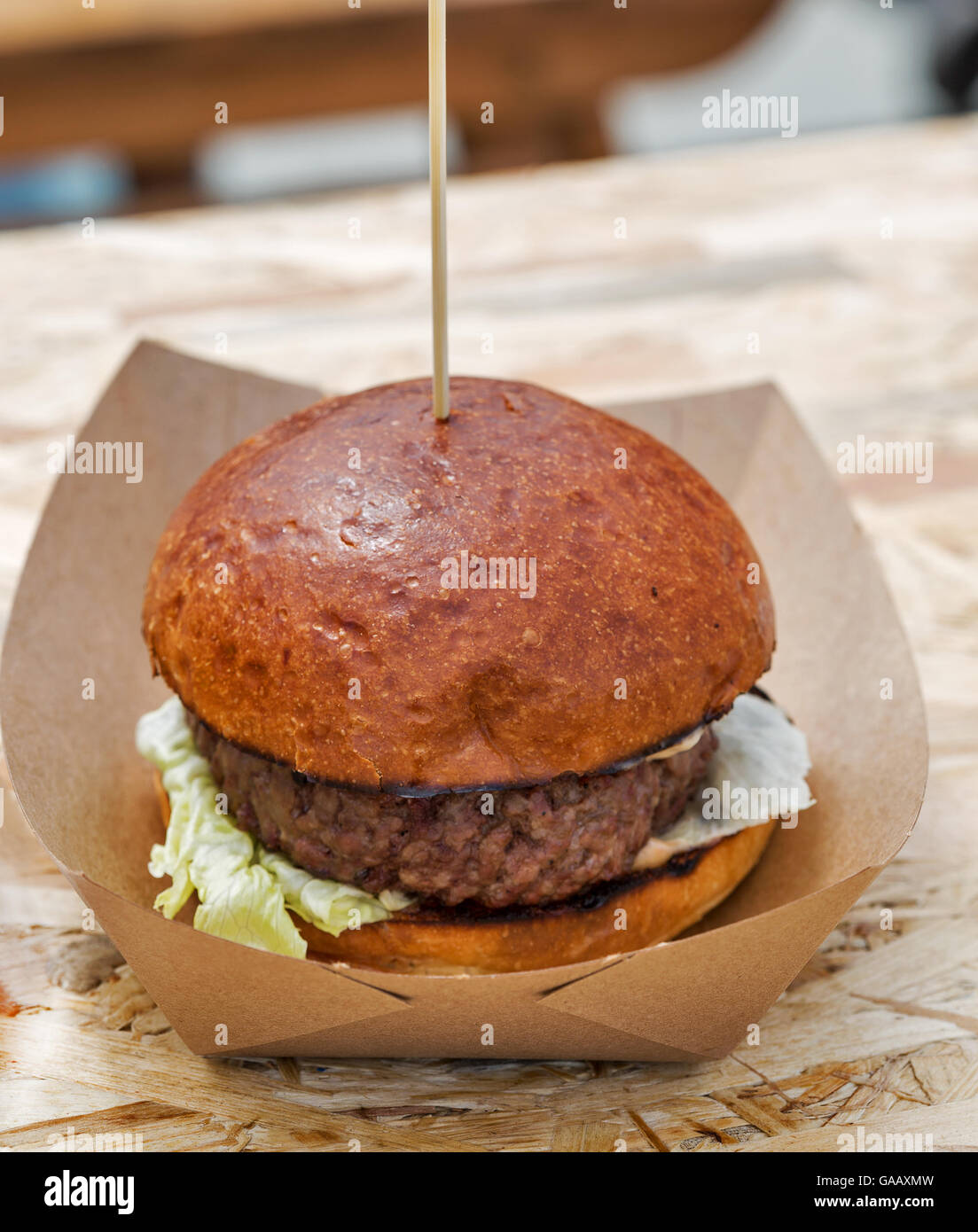 Street food hamburger on wooden table in paper plate closeup Stock ...
