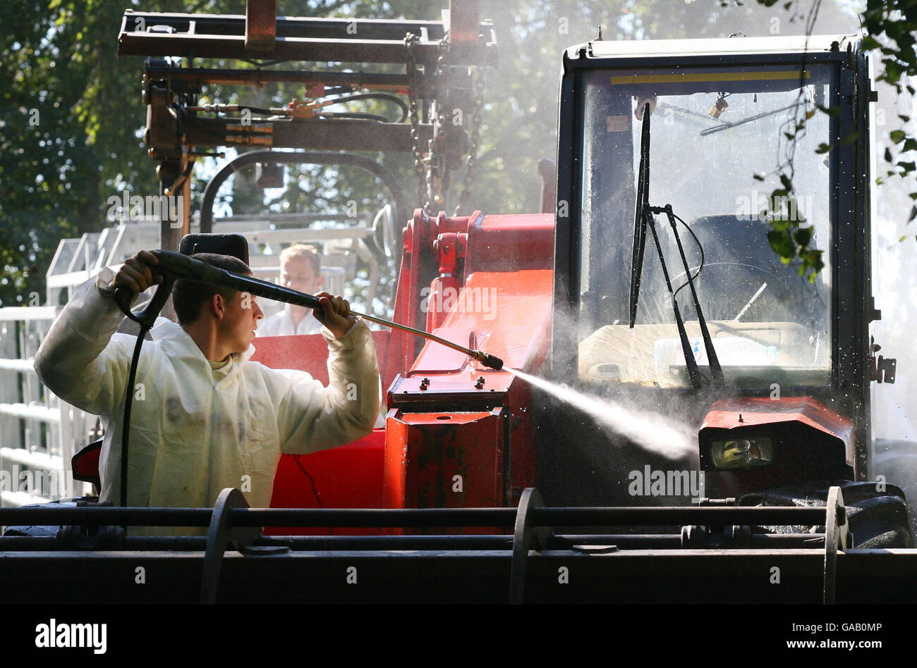 Agricultural contractors clean farm vehicles at a farm know locally as ...