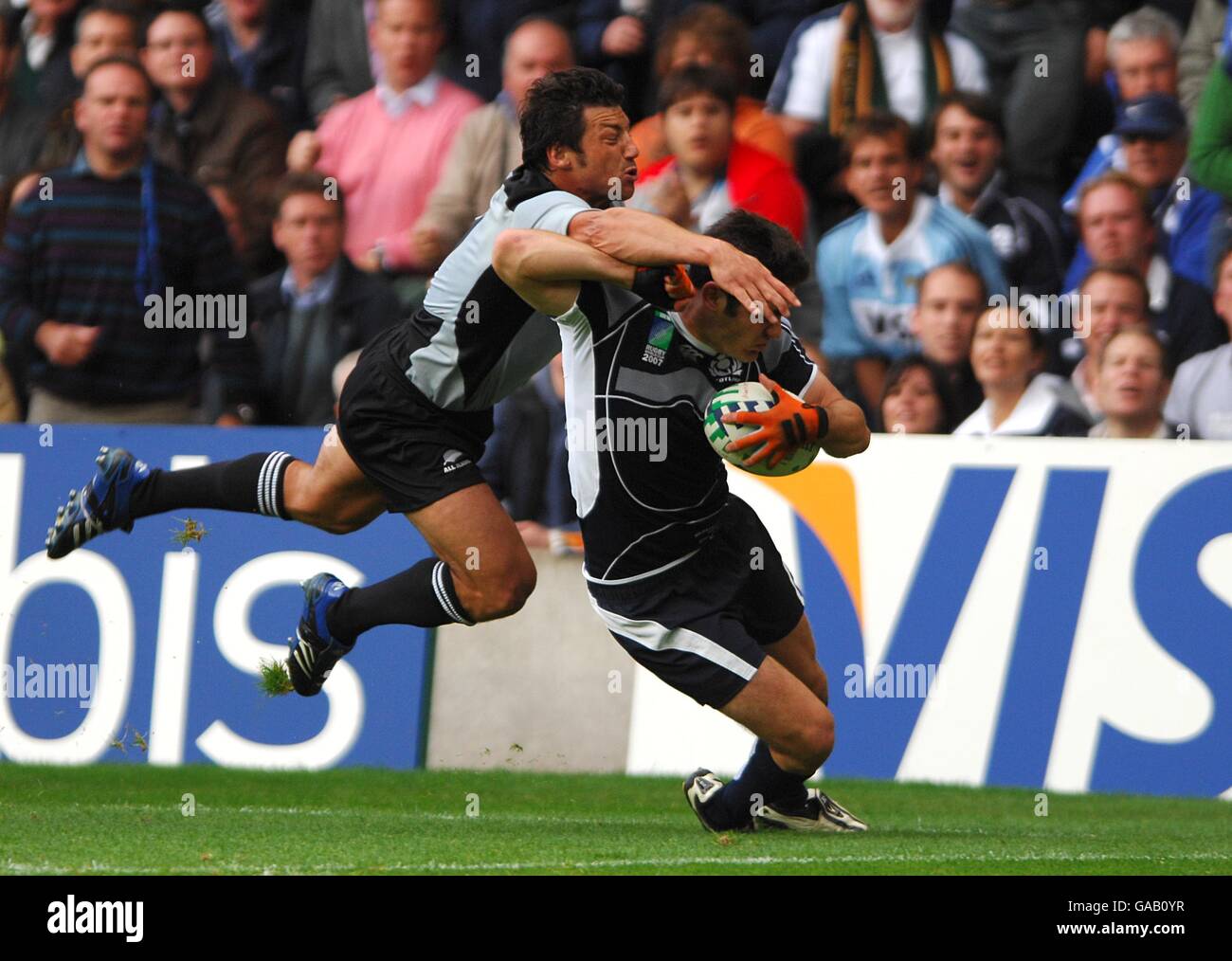 New Zealand's Byron Kelleher tries to stop Scotland's Marcus Di Rollo ...