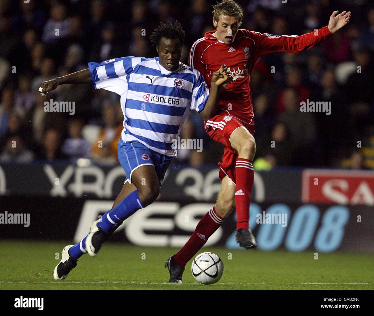 Liverpool's Peter Crouch (right) and Reading's Andre Bikey battle for ...