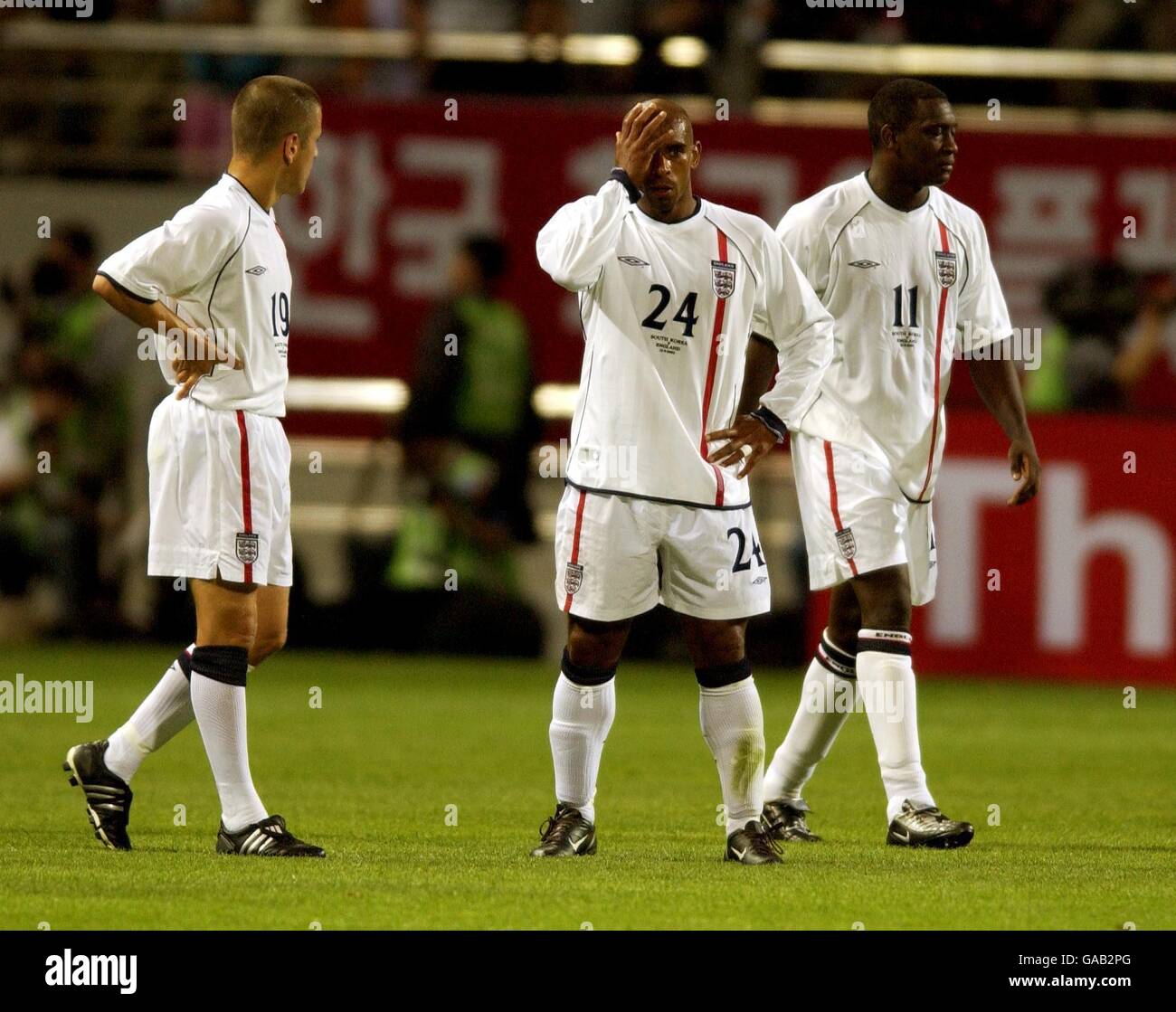 England's Joe Cole, Trevor Sinclair and Emile Heskey leave the pitch ...