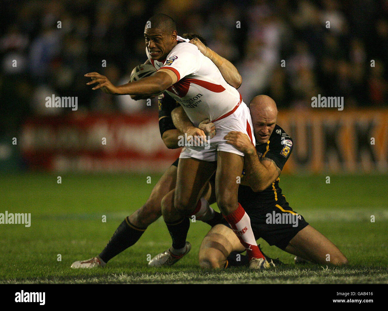 St Helen's Leon Pryce is tackled by Leeds' Keith Senior (right) and ...