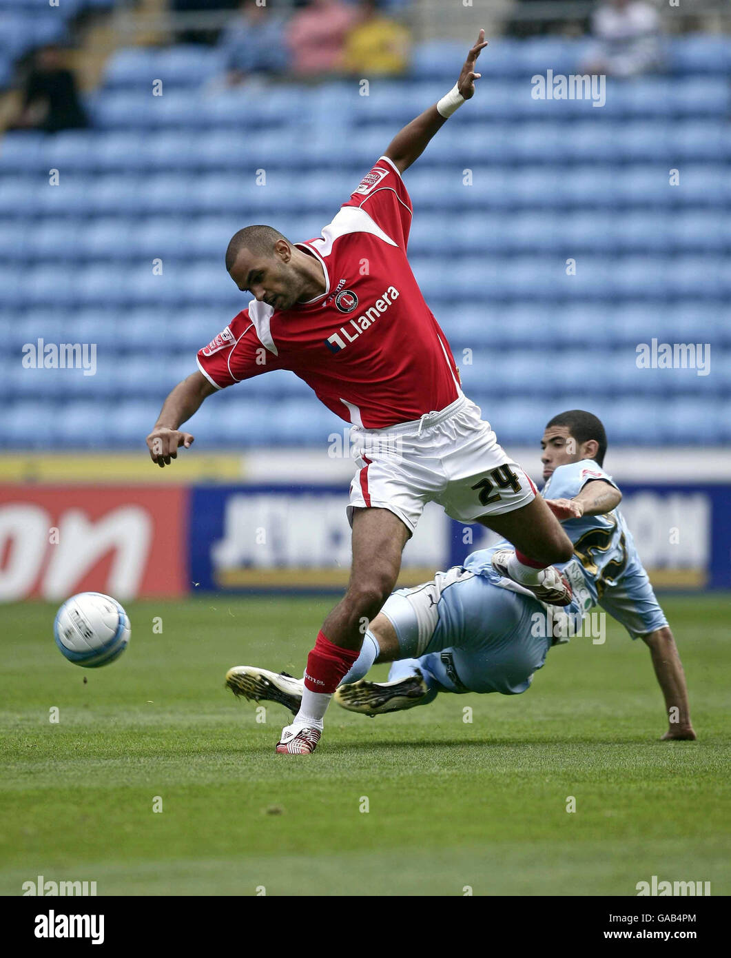 Charlton's Jon Fortune is tackled by Coventry's Leon Best (right ...