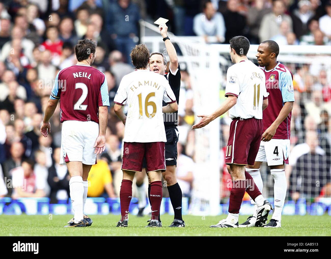 Arsenal's Mathieu Flamini is given a yellow card after fouling West Ham ...