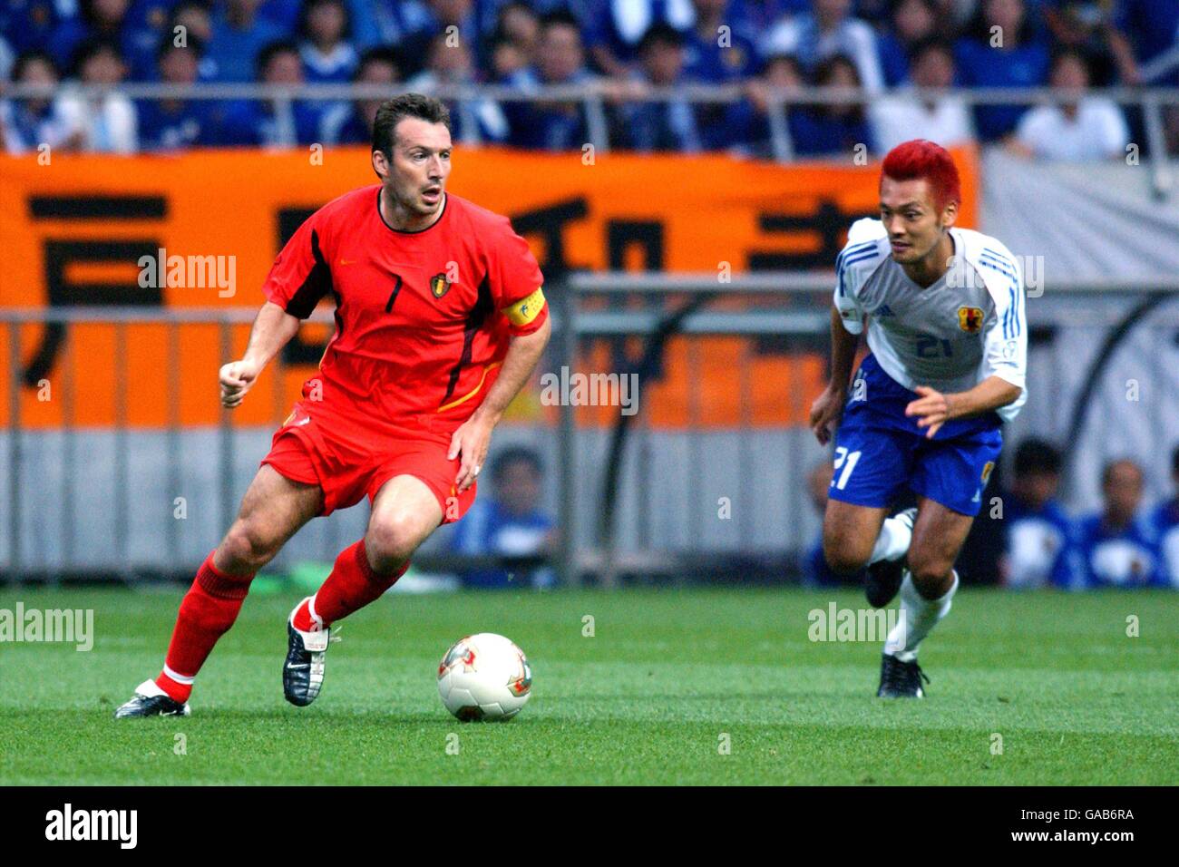 Belgiums marc wilmots l goes past japans kazuyuki toda hi-res stock ...