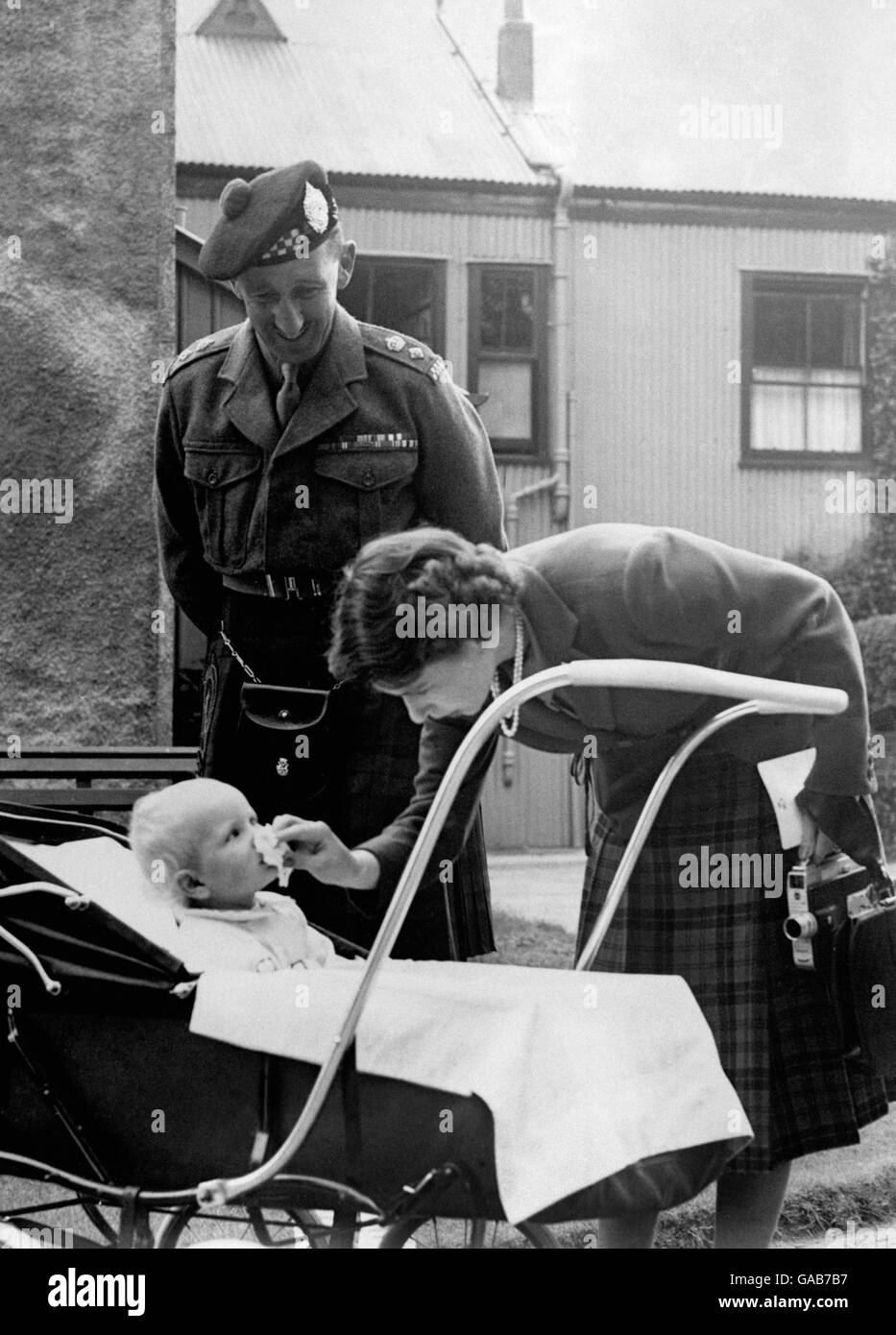 Princess Elizabeth stoops to wipe baby Princess Anne's nose before ...