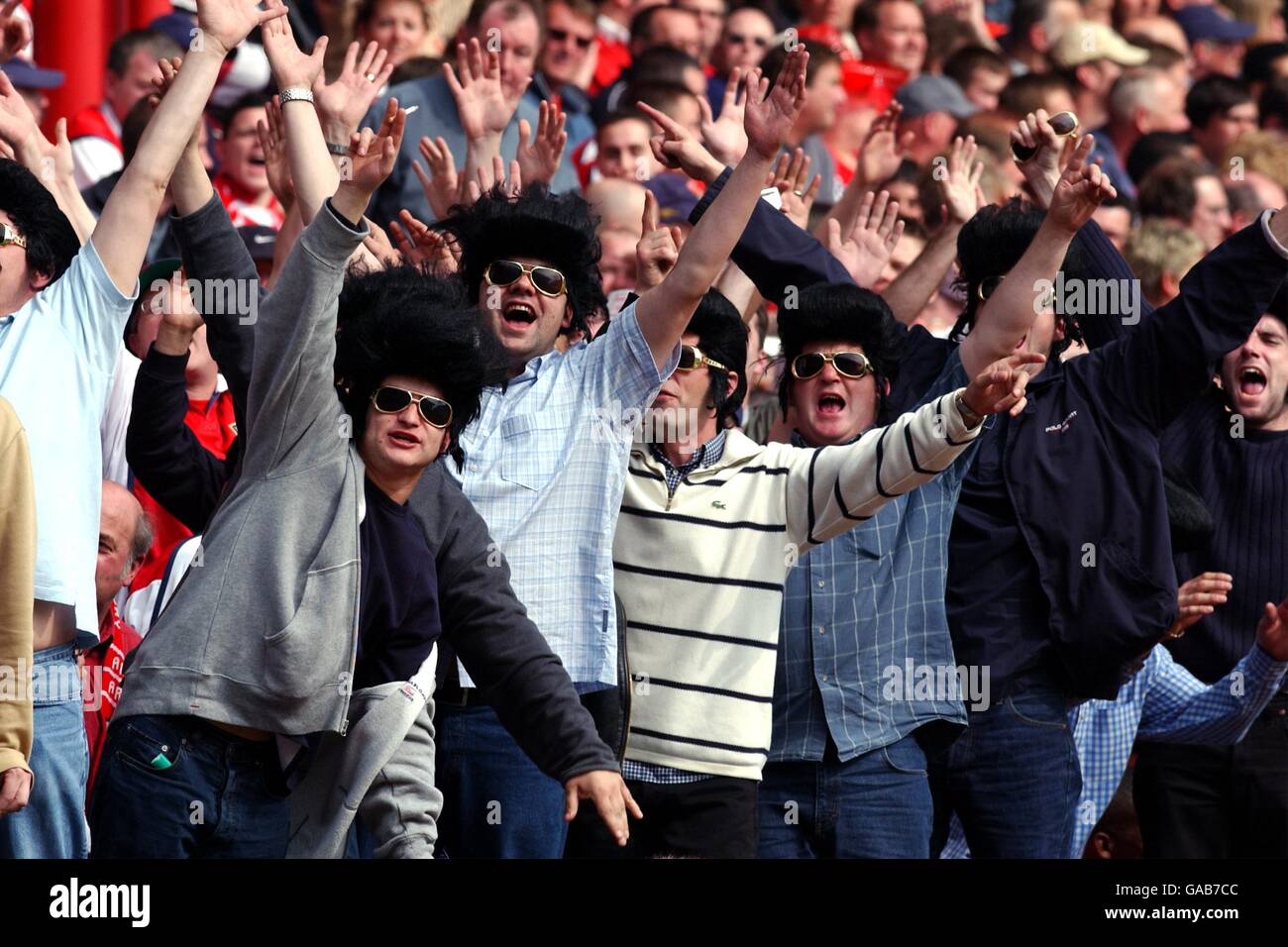 Arsenal fans dressed as elvis cheer on their team hi-res stock ...