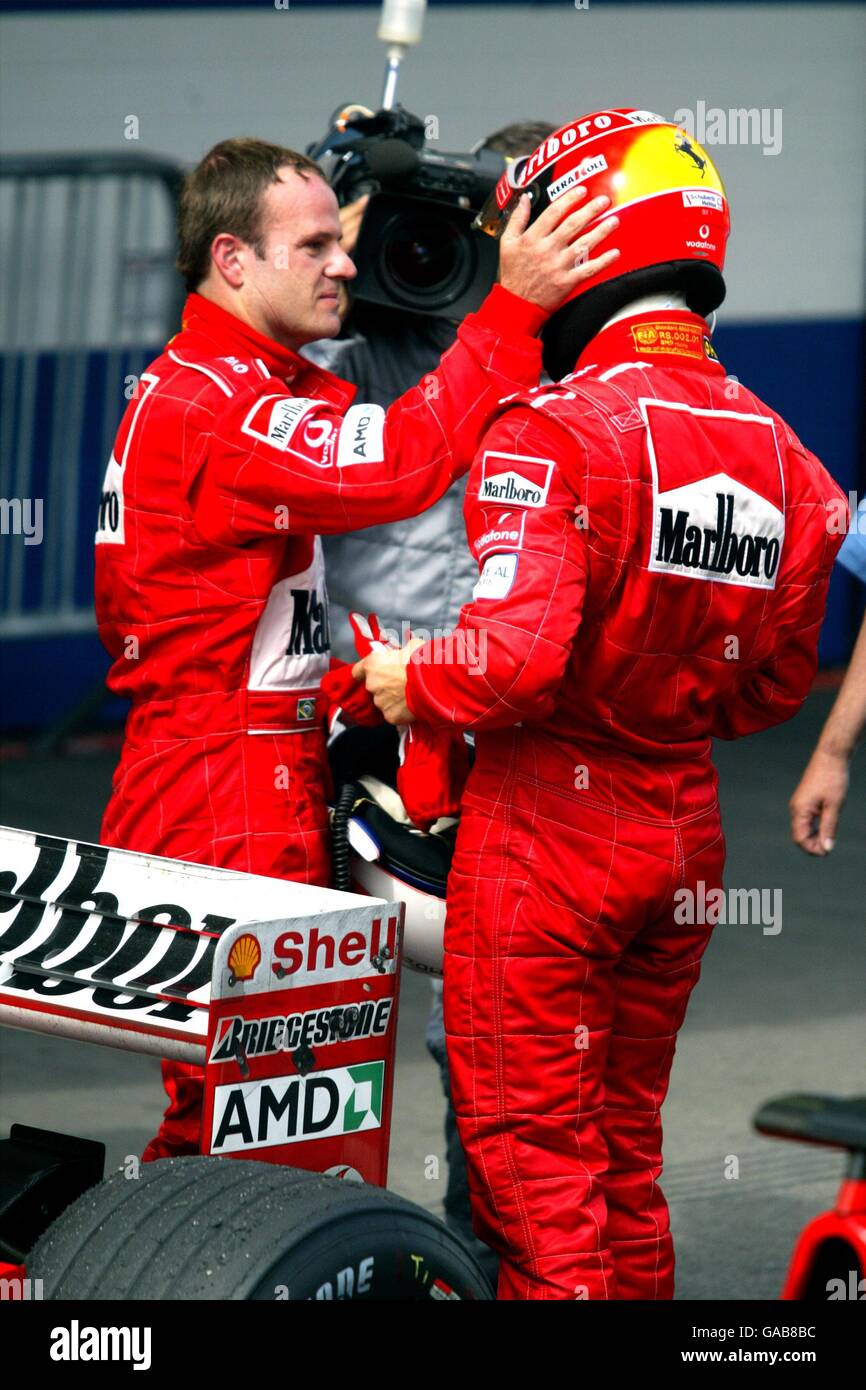 Ferrari's Rubens Barrichello (l) gives teamate Michael Schumacher (r) a ... Ferrari's Rubens Barrichello (l) gives teamate Michael Schumacher (r) a ...