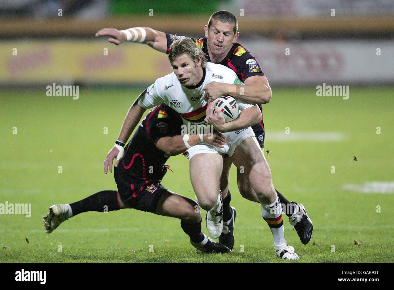 Glenn Morrison is tackled by Thomas Leuluai (left) and Brian Fletcher ...