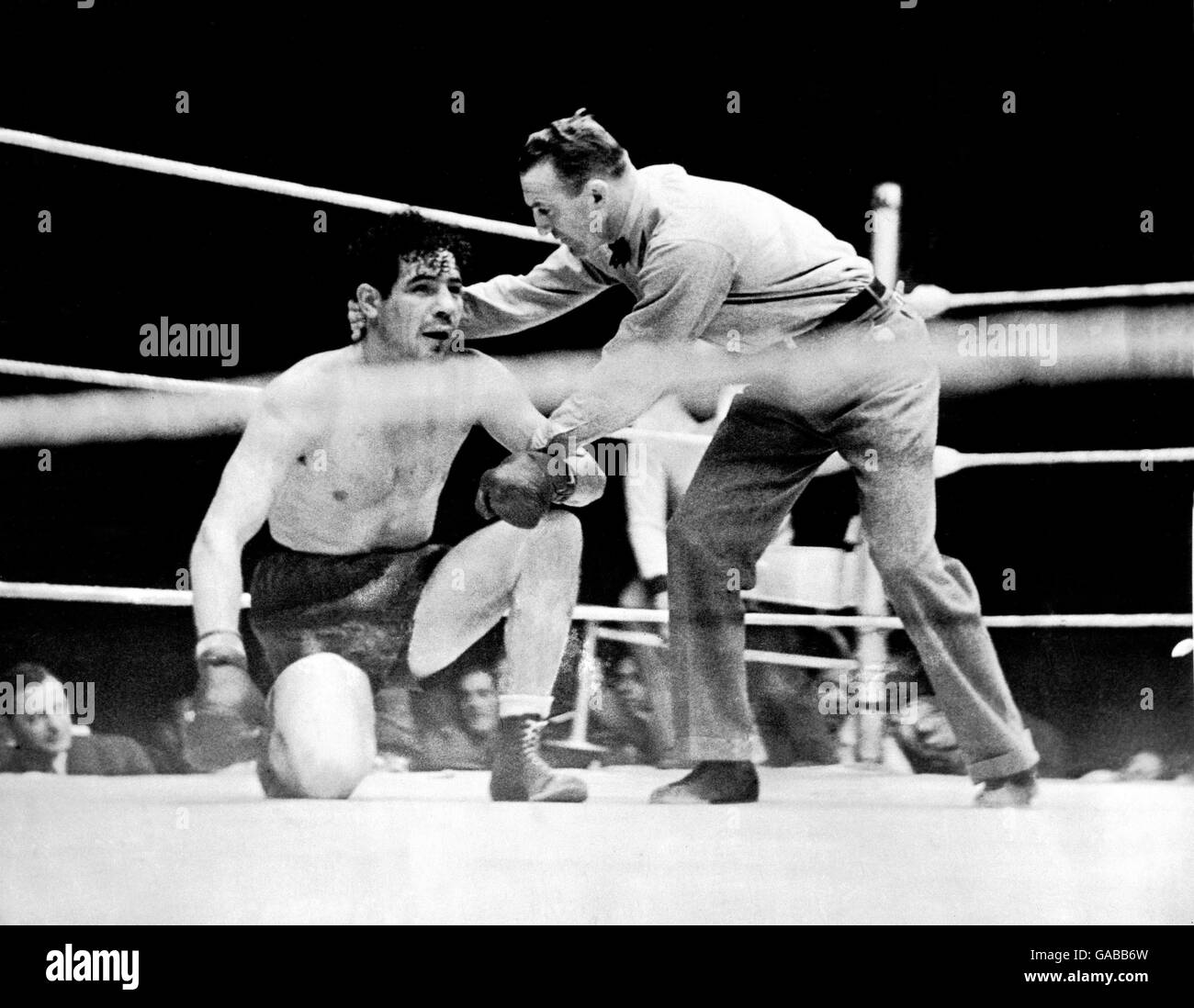 Referee Arthur Donovan, right, helps the defeated former Champion Max ...