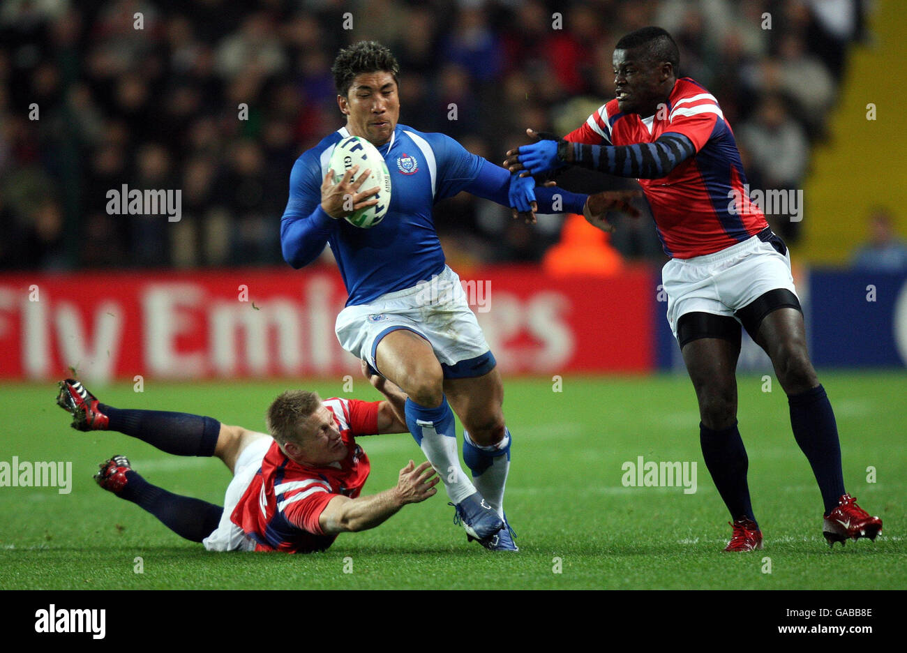 Samoa's Loki Crichton hands off the tackle of USA's Takudzwa Ngwenya ...