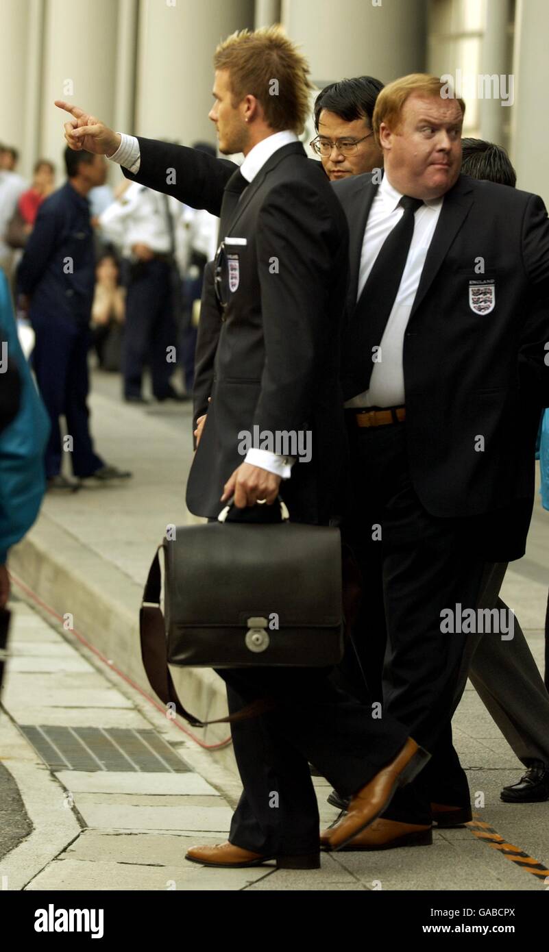 England team security officer Ray Whitworth ushers David Beckham to the ...