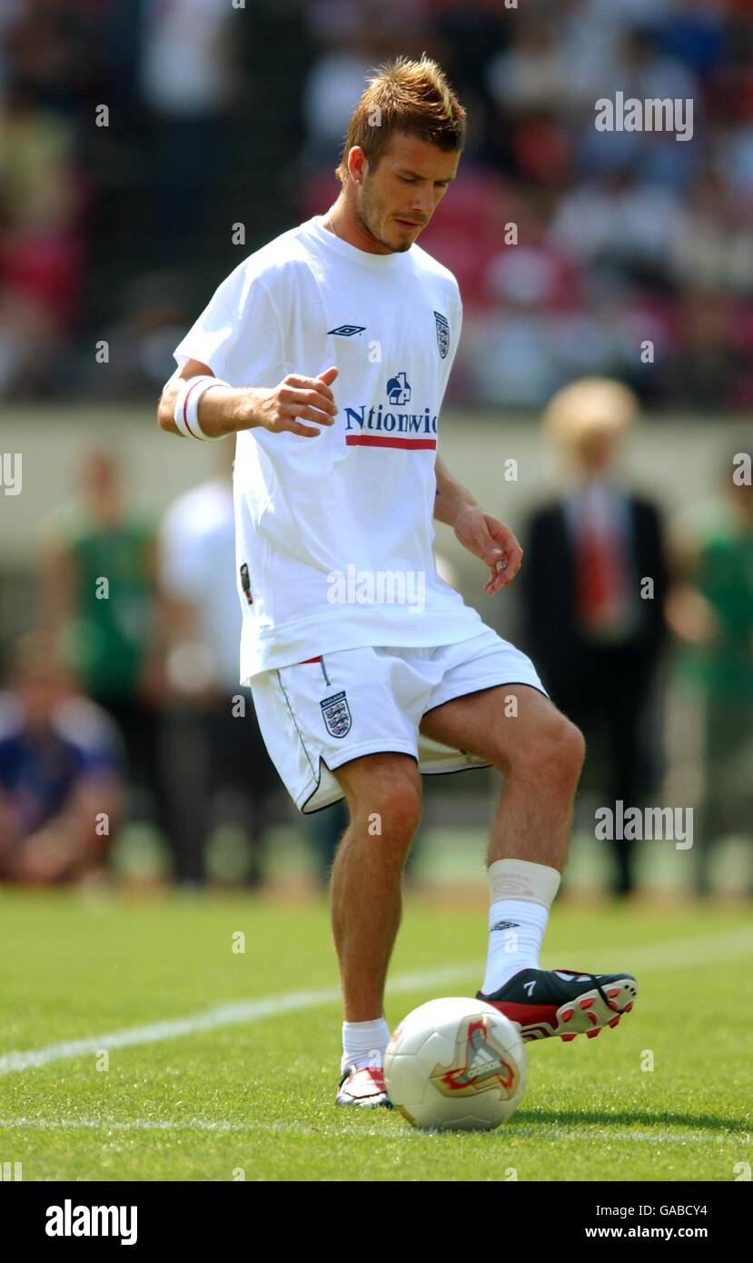 England's David Beckham trains before the match, kicking the ball with ...
