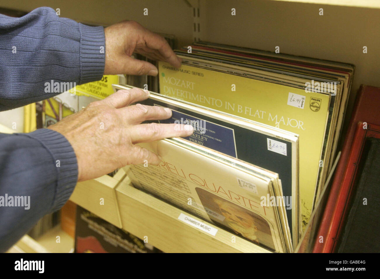 A member of the public flicks through records at the first Oxfam Shop ...