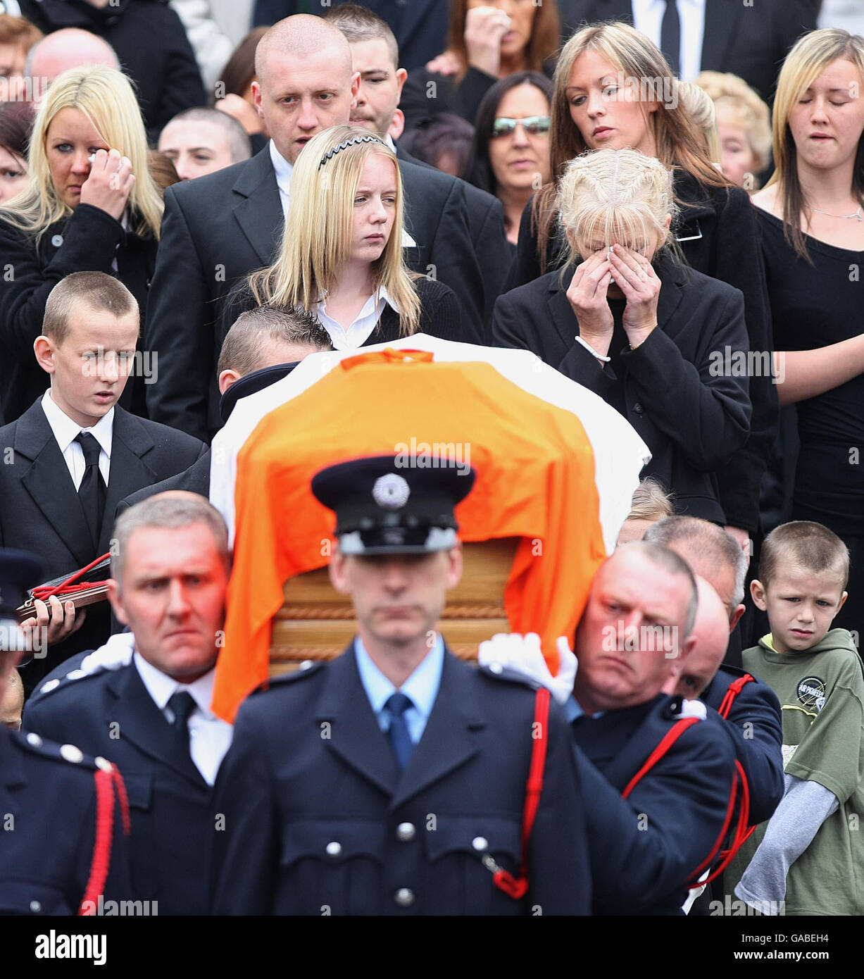 Family members cry as they follow the coffin of firefighter Brian ...