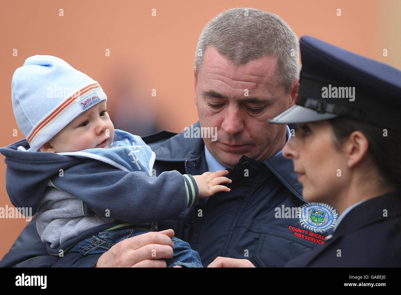 Wicklow Fire Brigade members with a young infant, at the funeral of ...