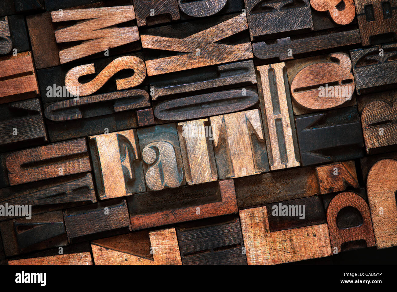 faith word made from wooden letterpress blocks inside many letters ...