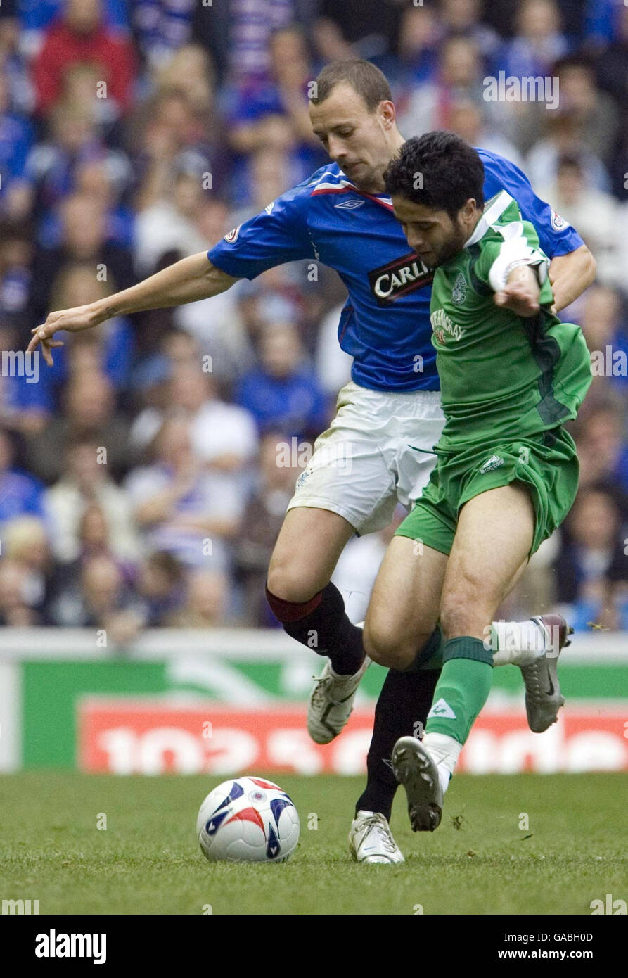 Alan Hutton of Rangers battles with Merouane Zemmama of Hibernian ...
