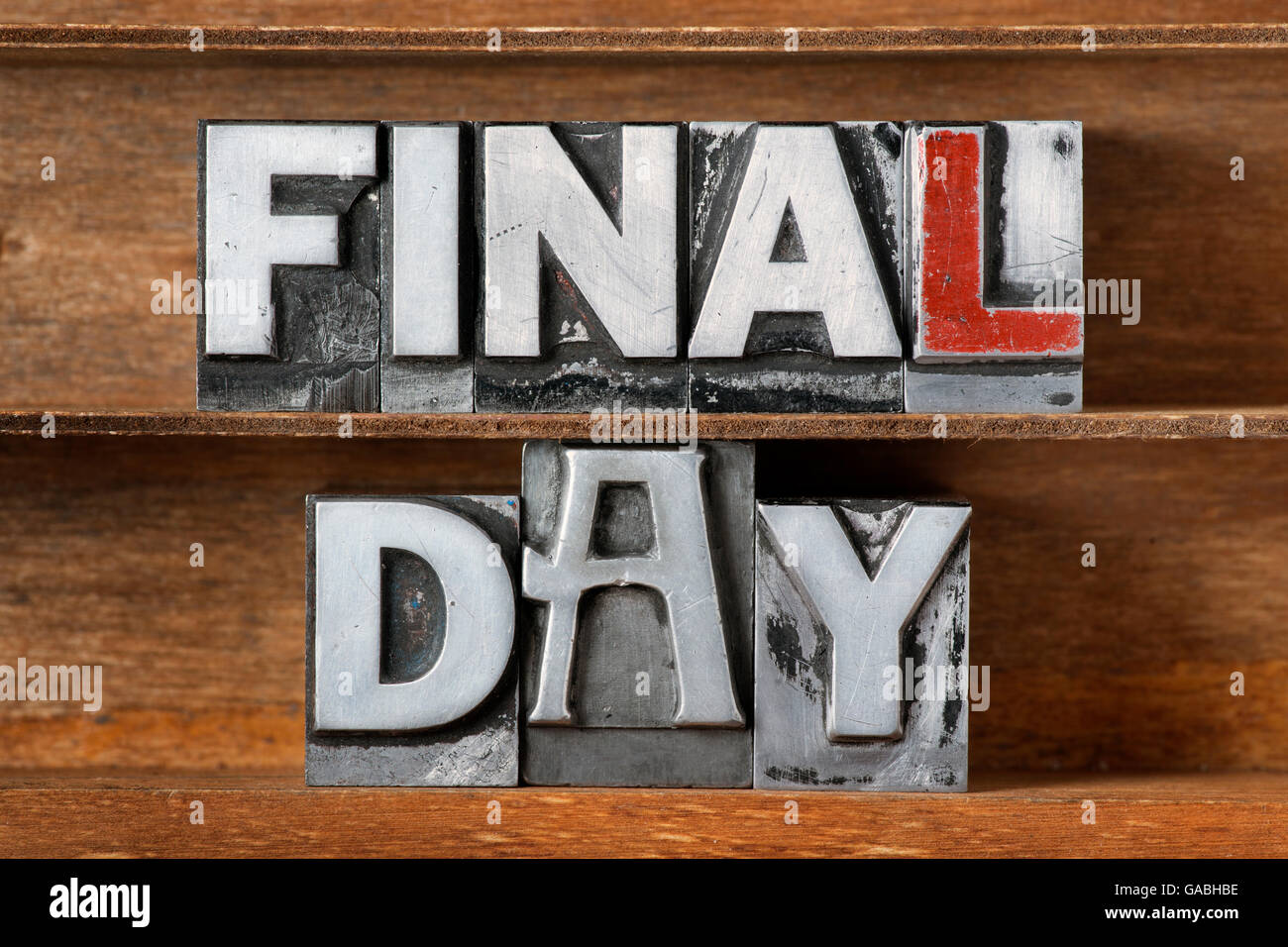 final day phrase made from metallic letterpress type on wooden tray ...